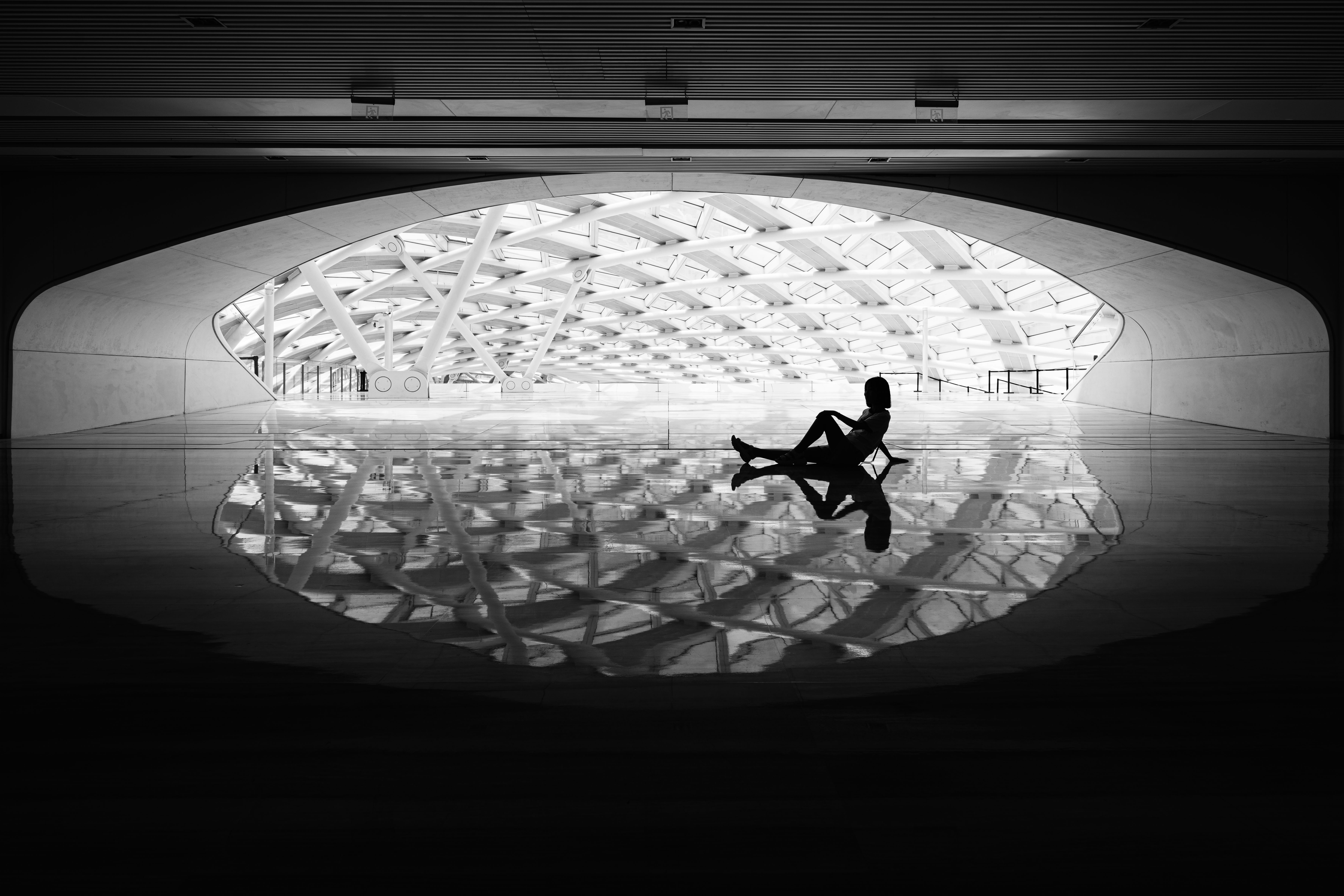 Harmonious Reflection: A Solitary Moment in Architectural Elegance