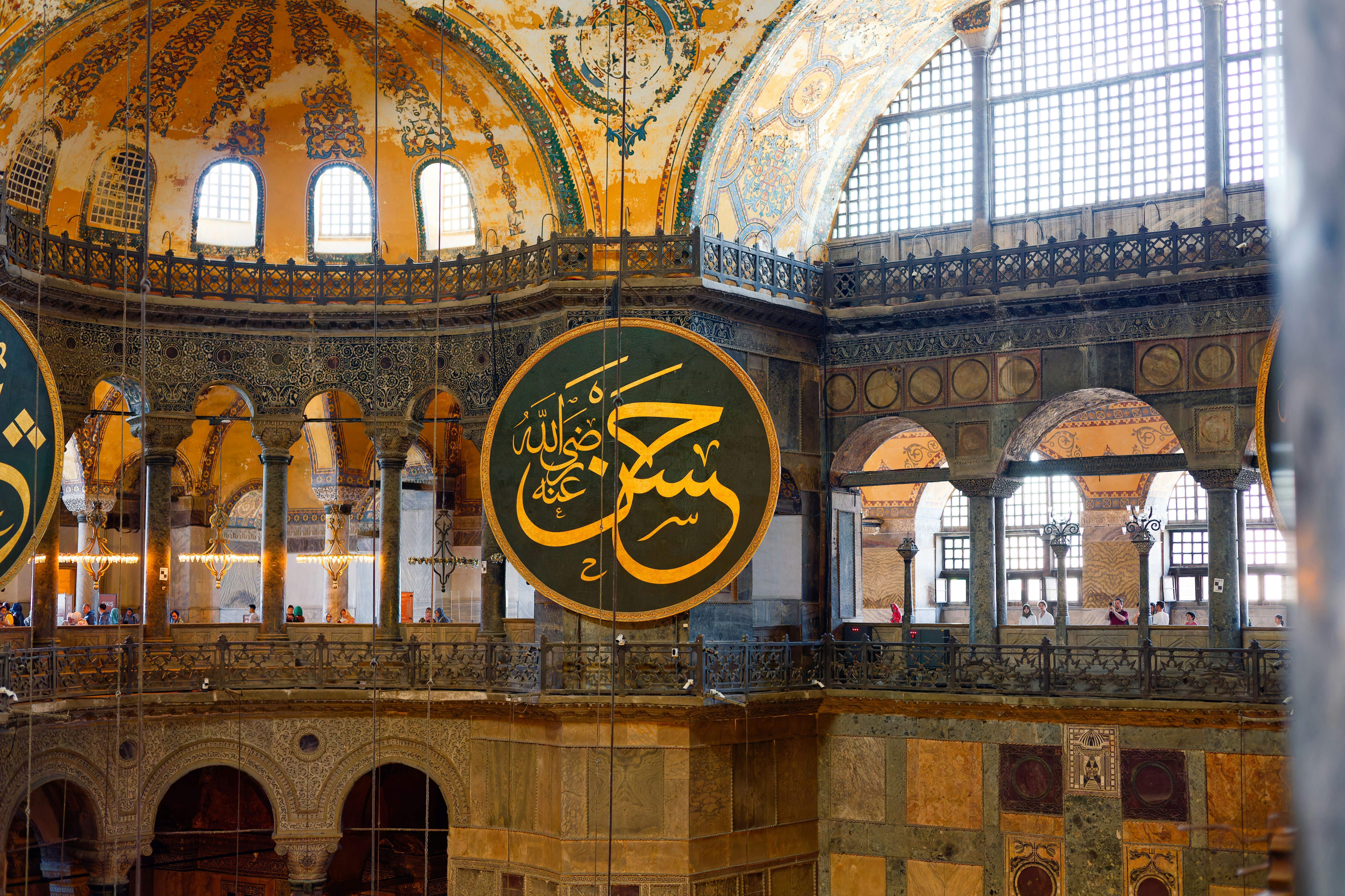 Intricate calligraphy adorns the interior of Hagia Sophia, showcasing its architectural beauty and historical significance.