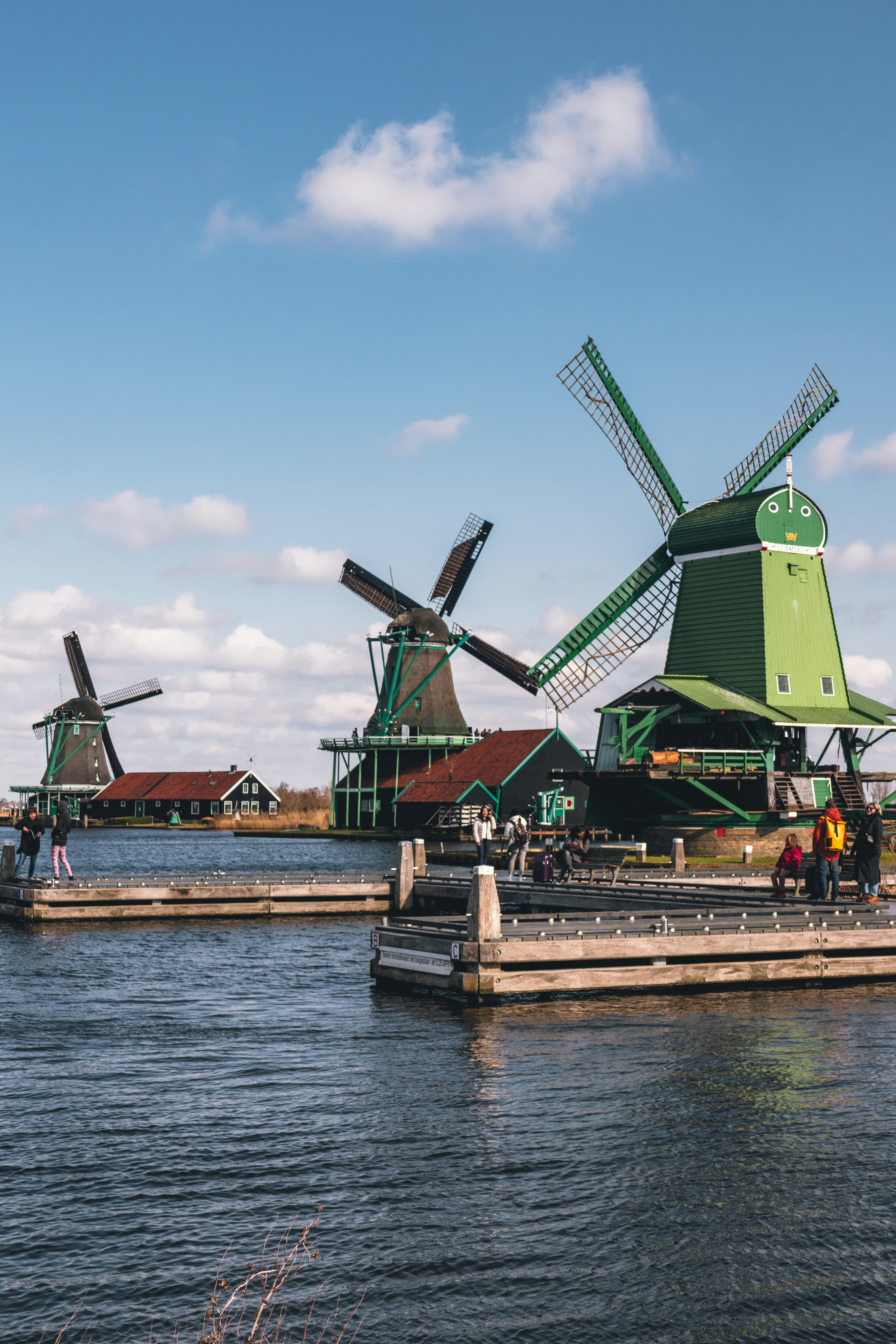 3 colorful windmills in the cute village of Zaanse Schans, Netherlands