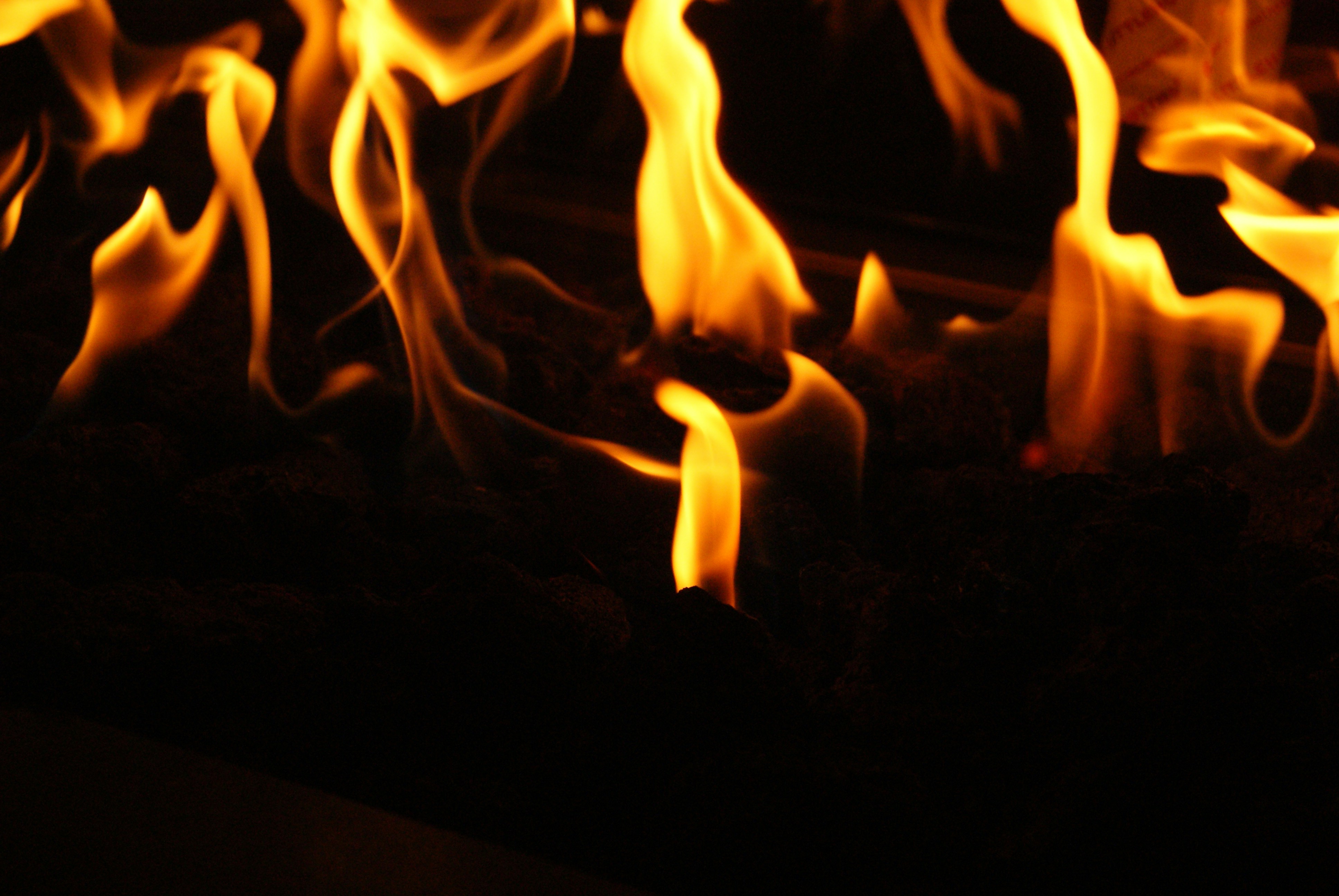 Flames dance against a dark backdrop.