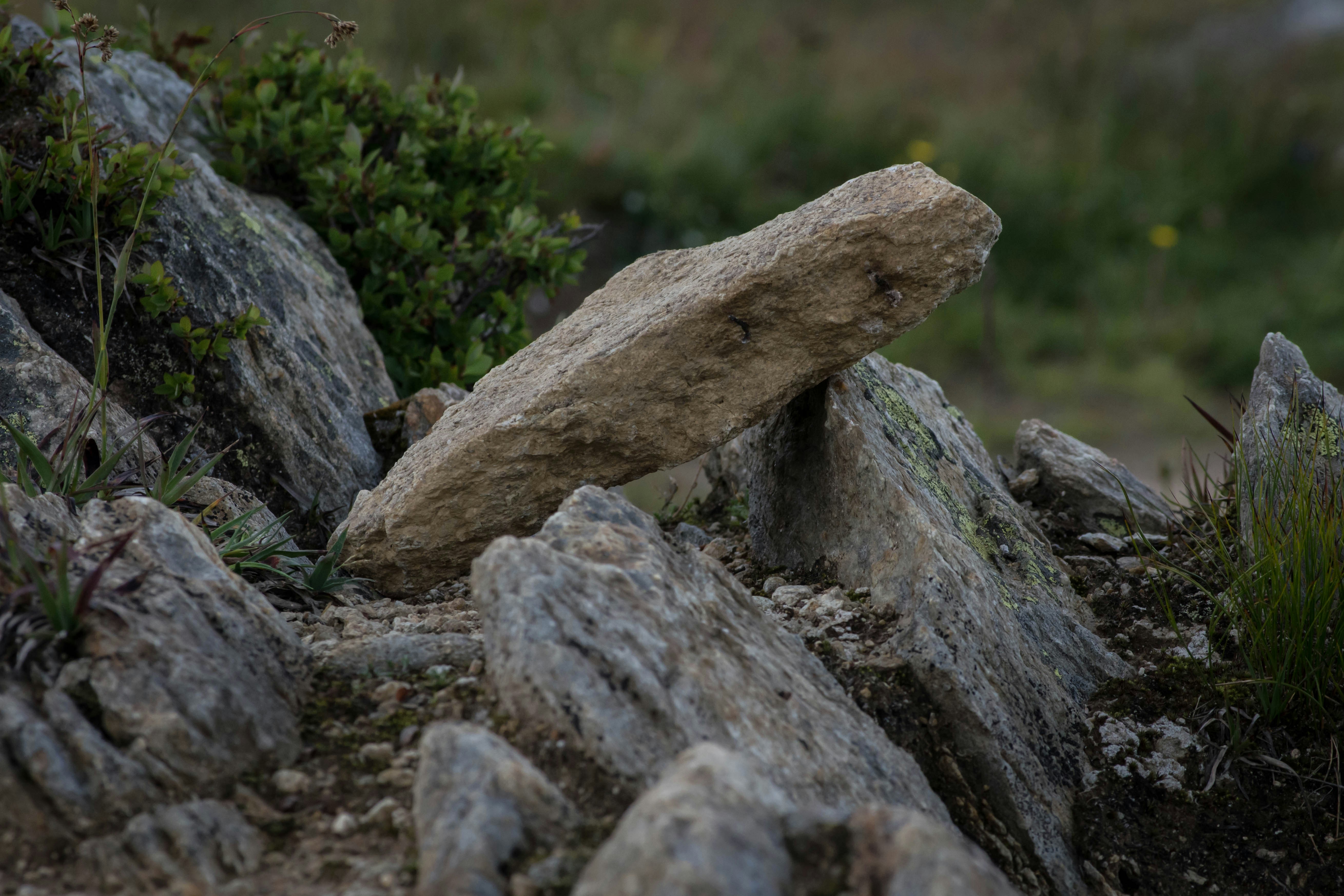 A rock leans on other rocks.