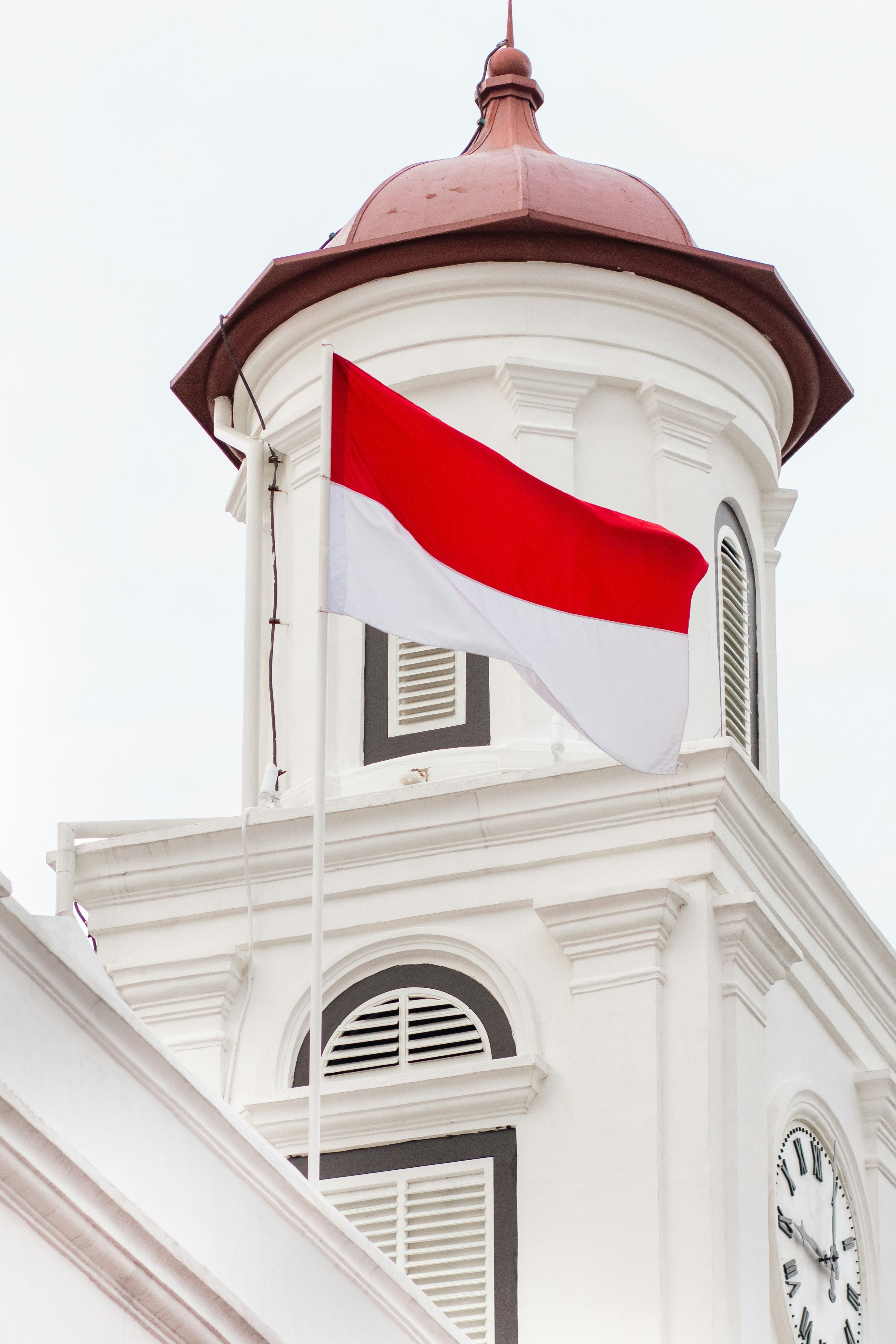Blenduk church building in Semarang | The indonesian flag flies high above a building.