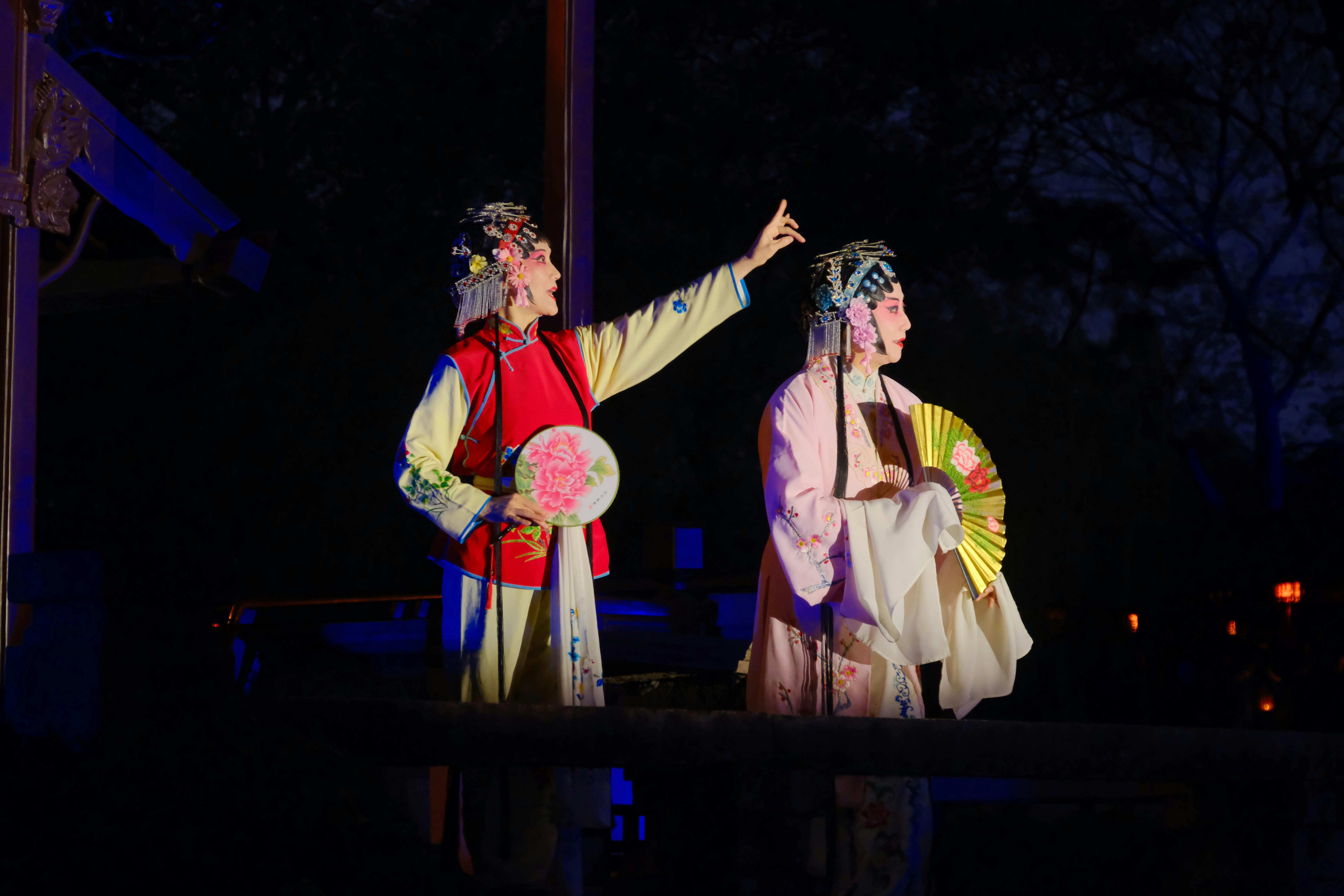 Midnight Stage Duo: Lantern-lit Performers in Vivid Traditional Attire