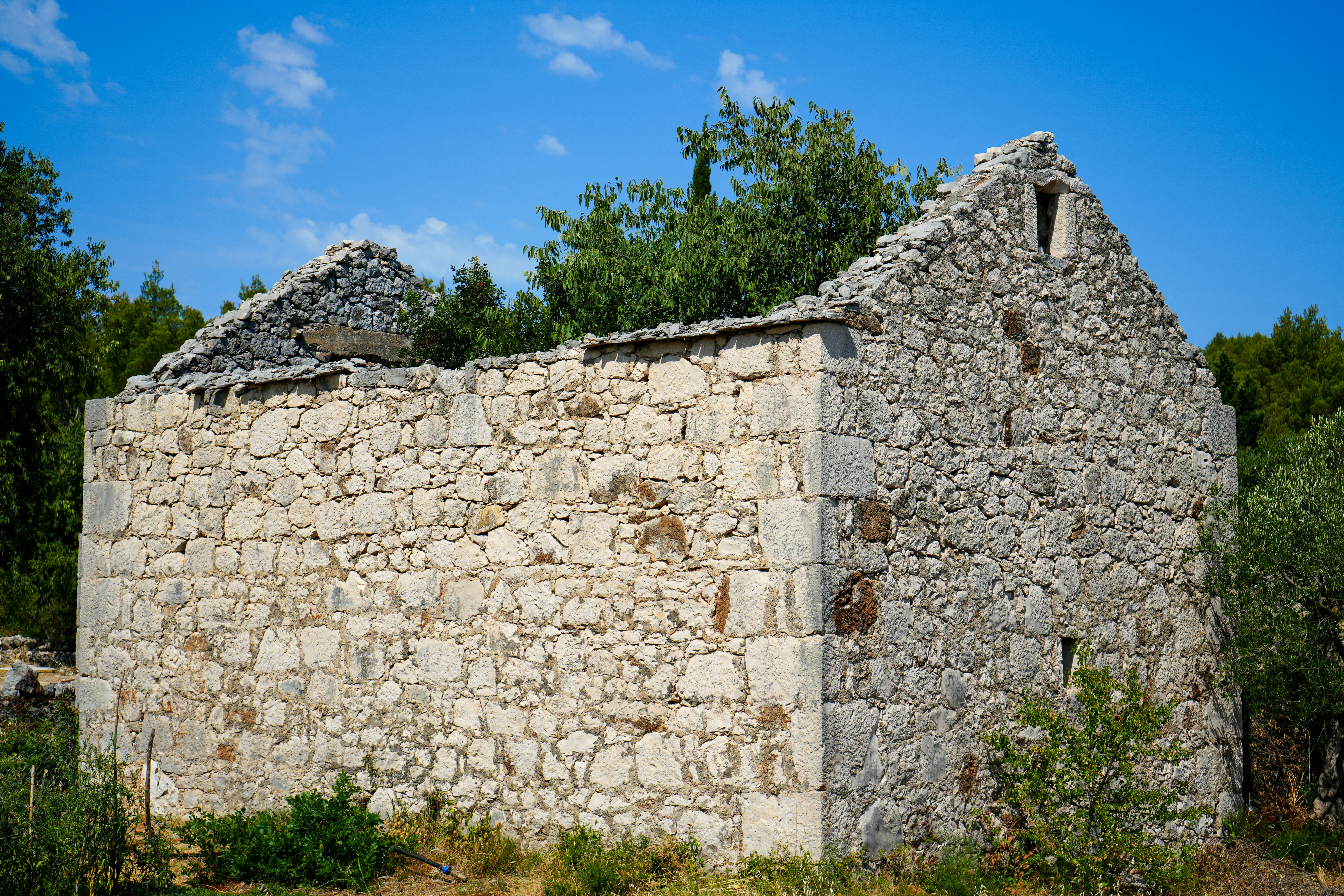 Ruin of a stone building stands against the sky.