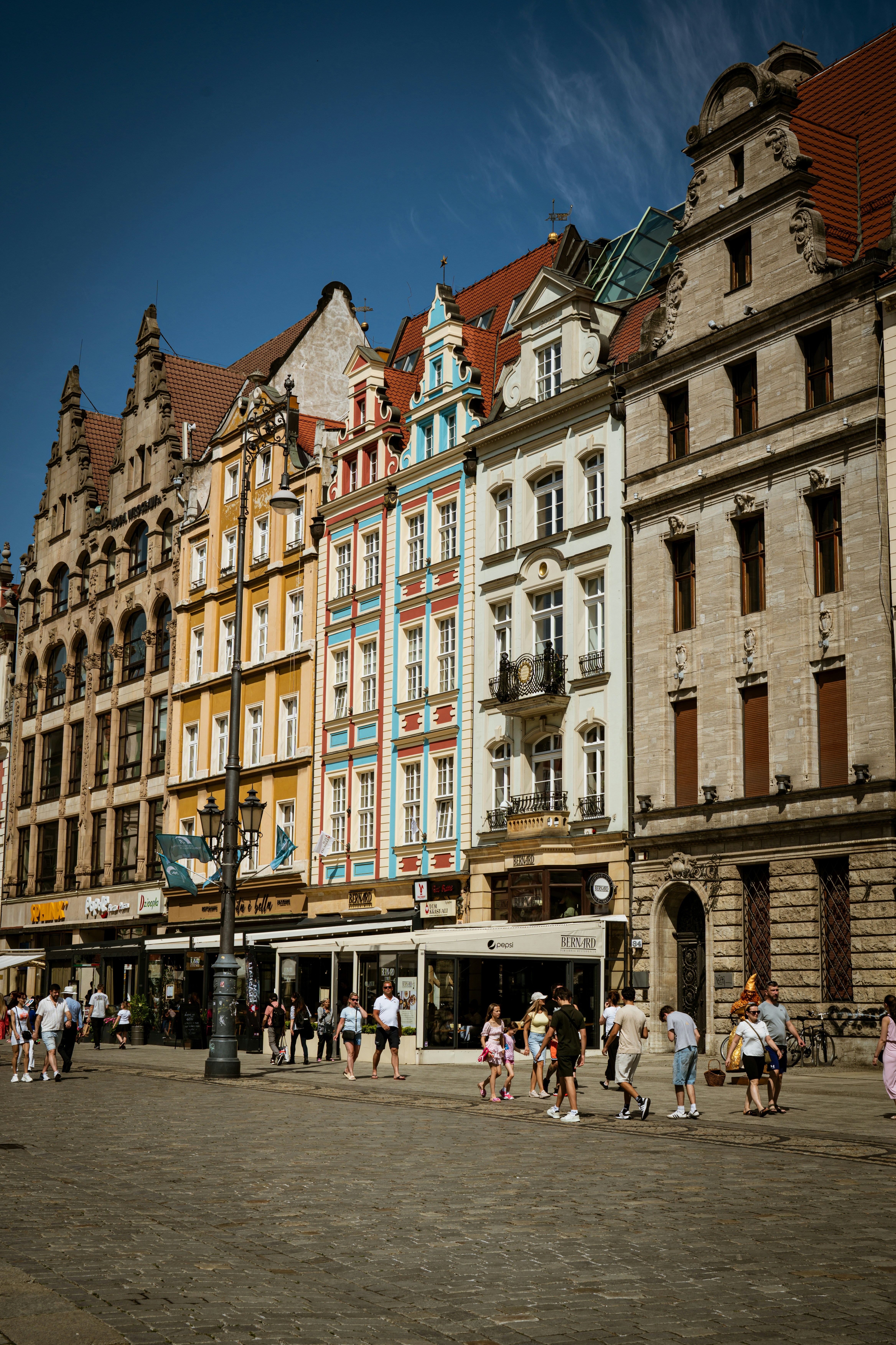Colorful buildings line a european city square.