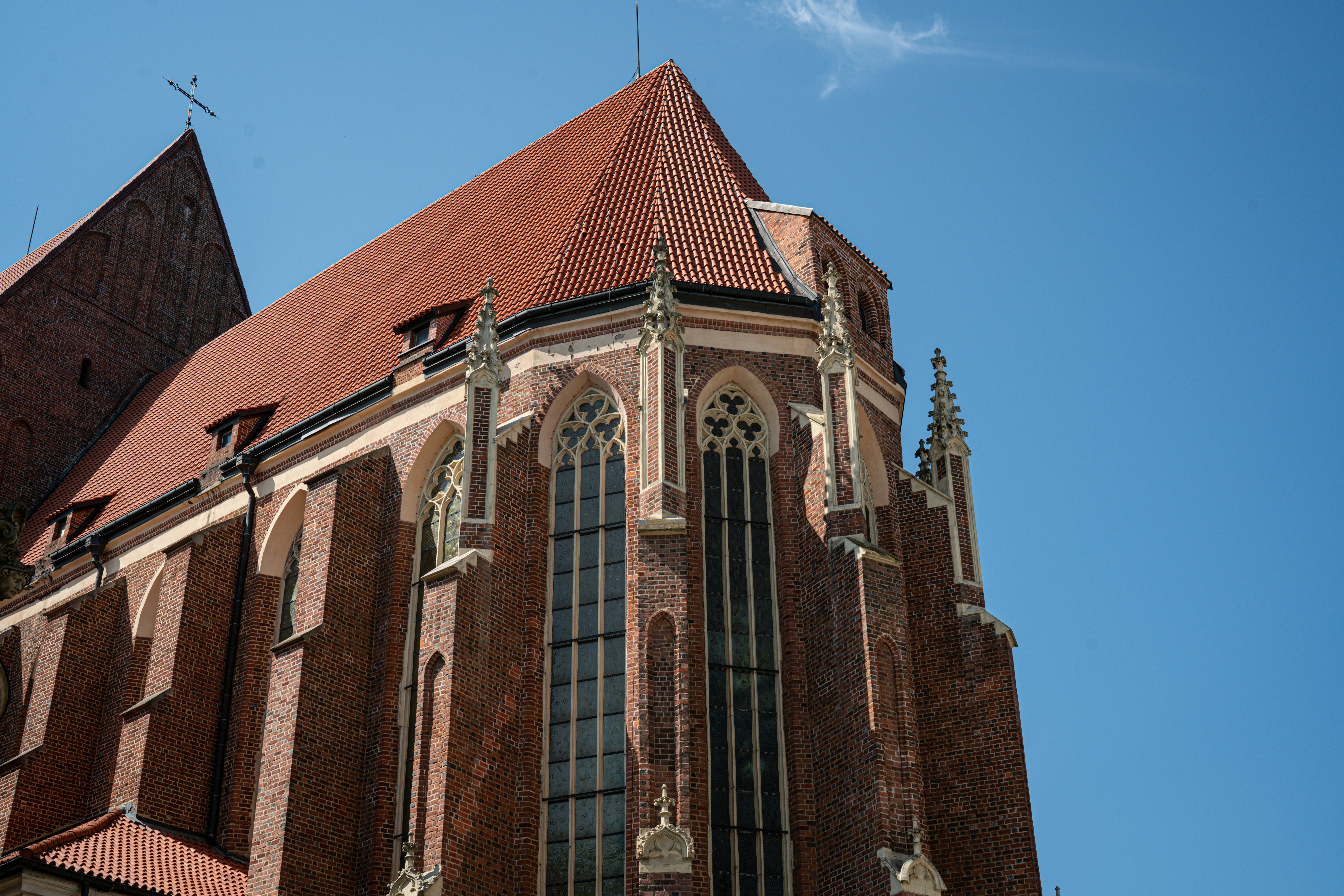 A church with a red roof and arched windows.