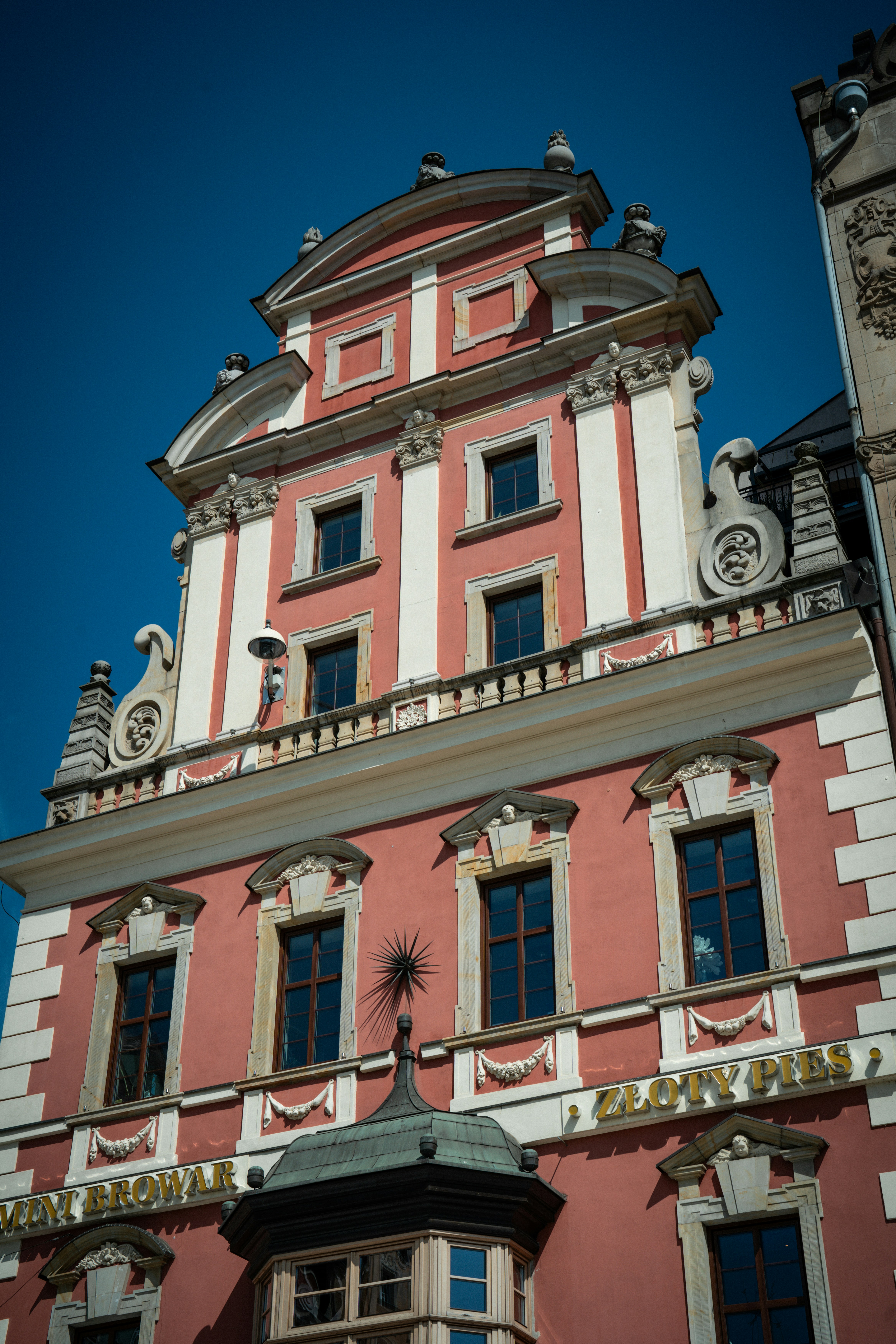 An ornate building with a pink and white facade.