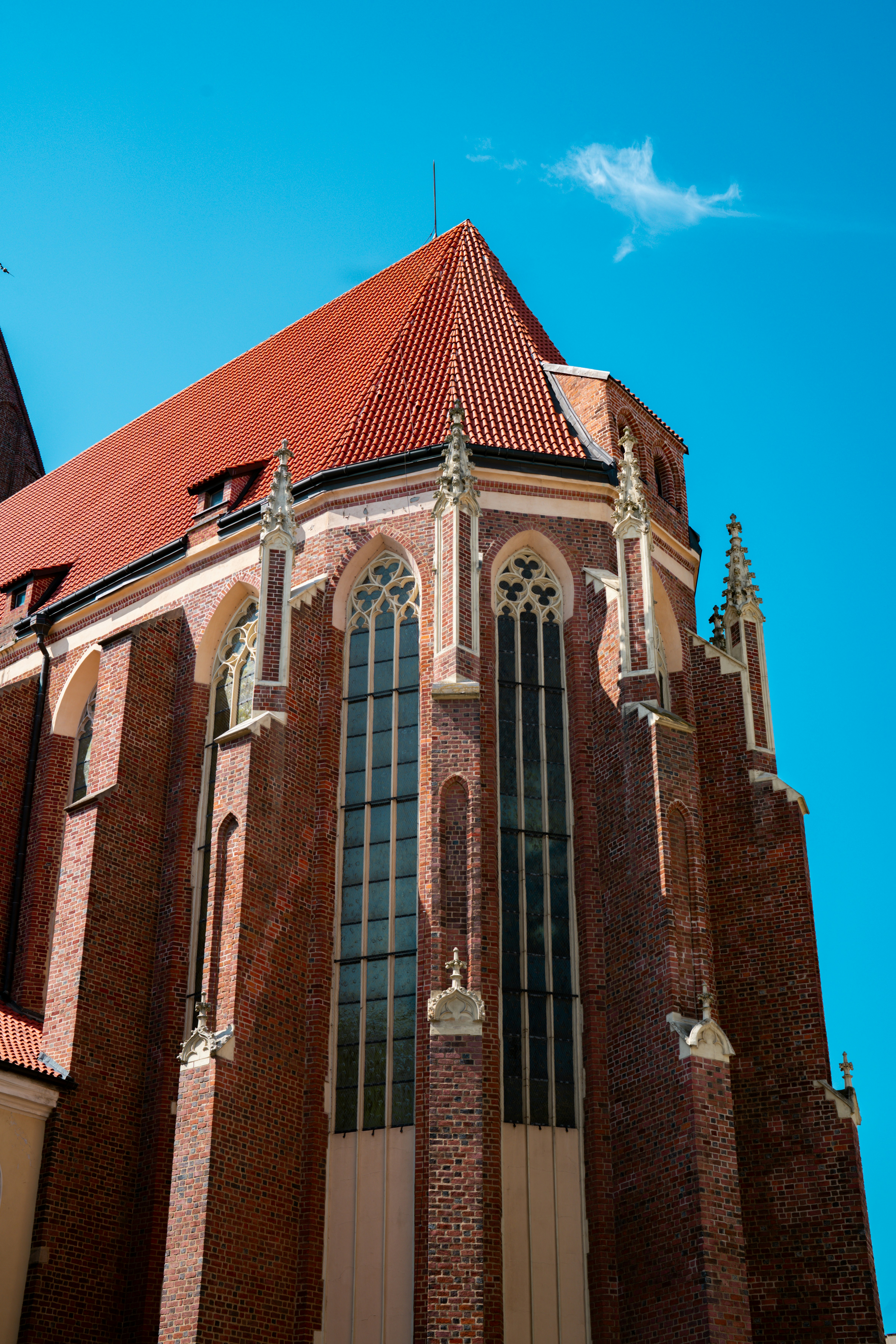 Church building with a red roof under a blue sky.