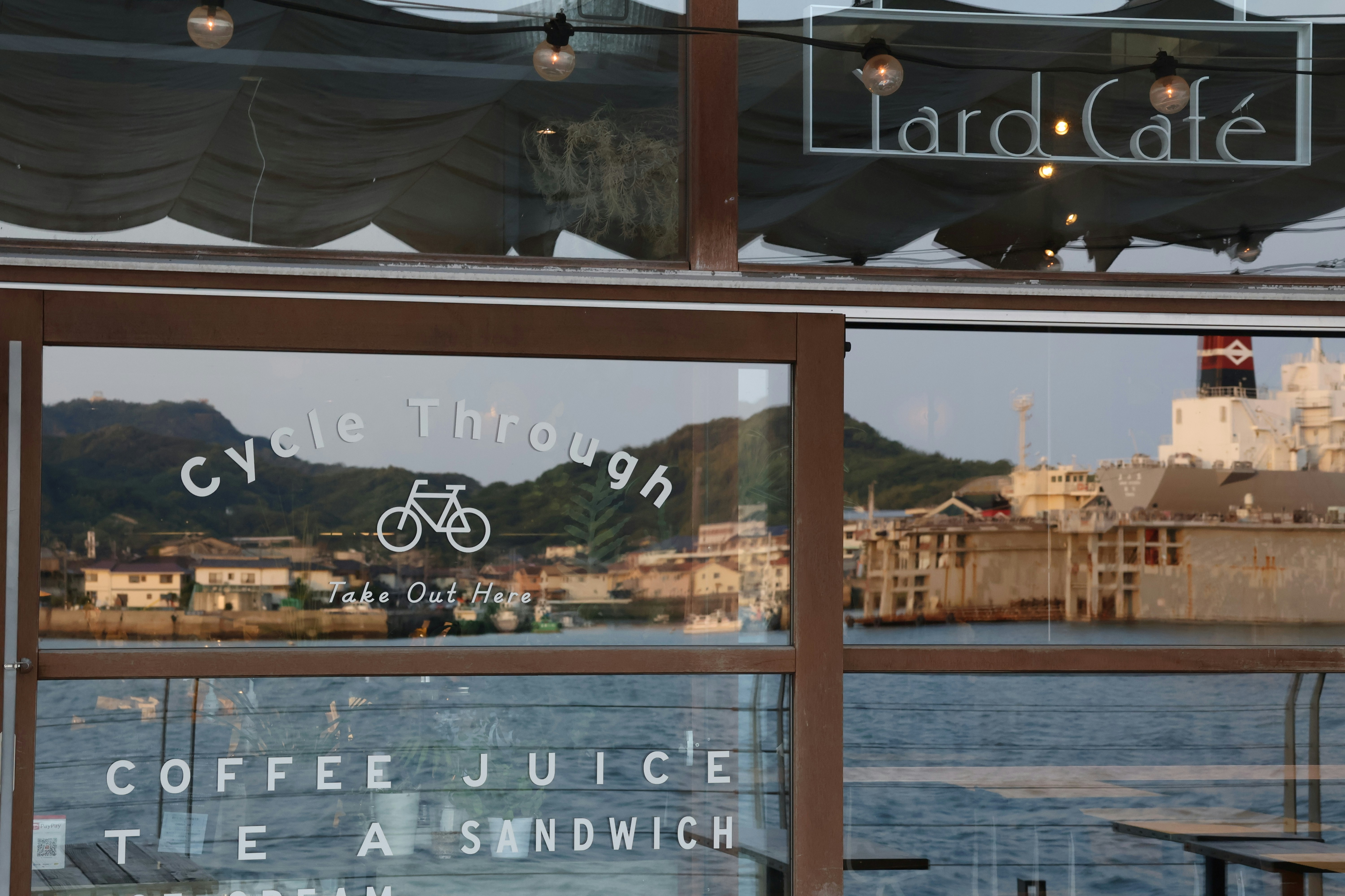 A cafe's window view of the coast.