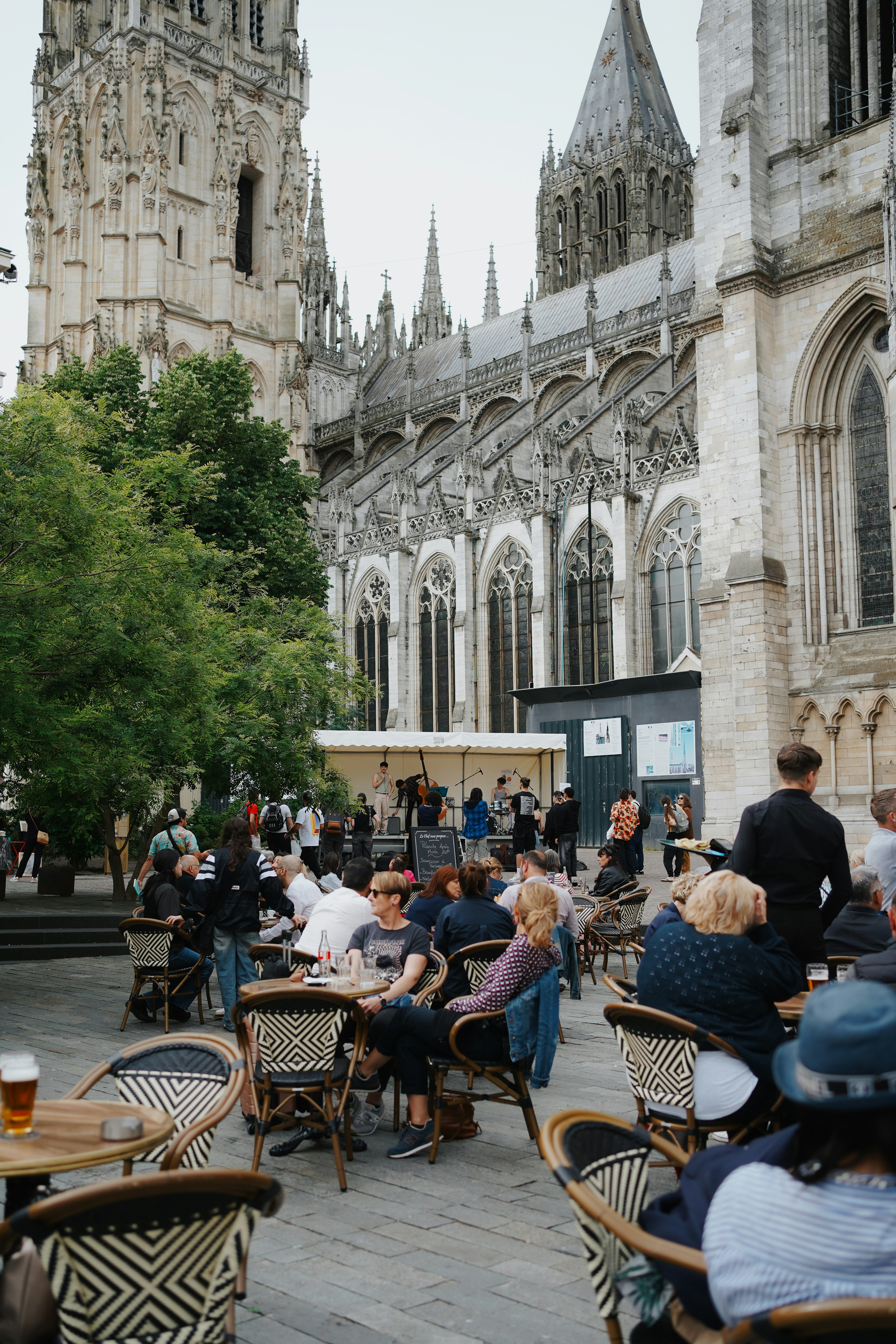 People relax outside a cathedral.