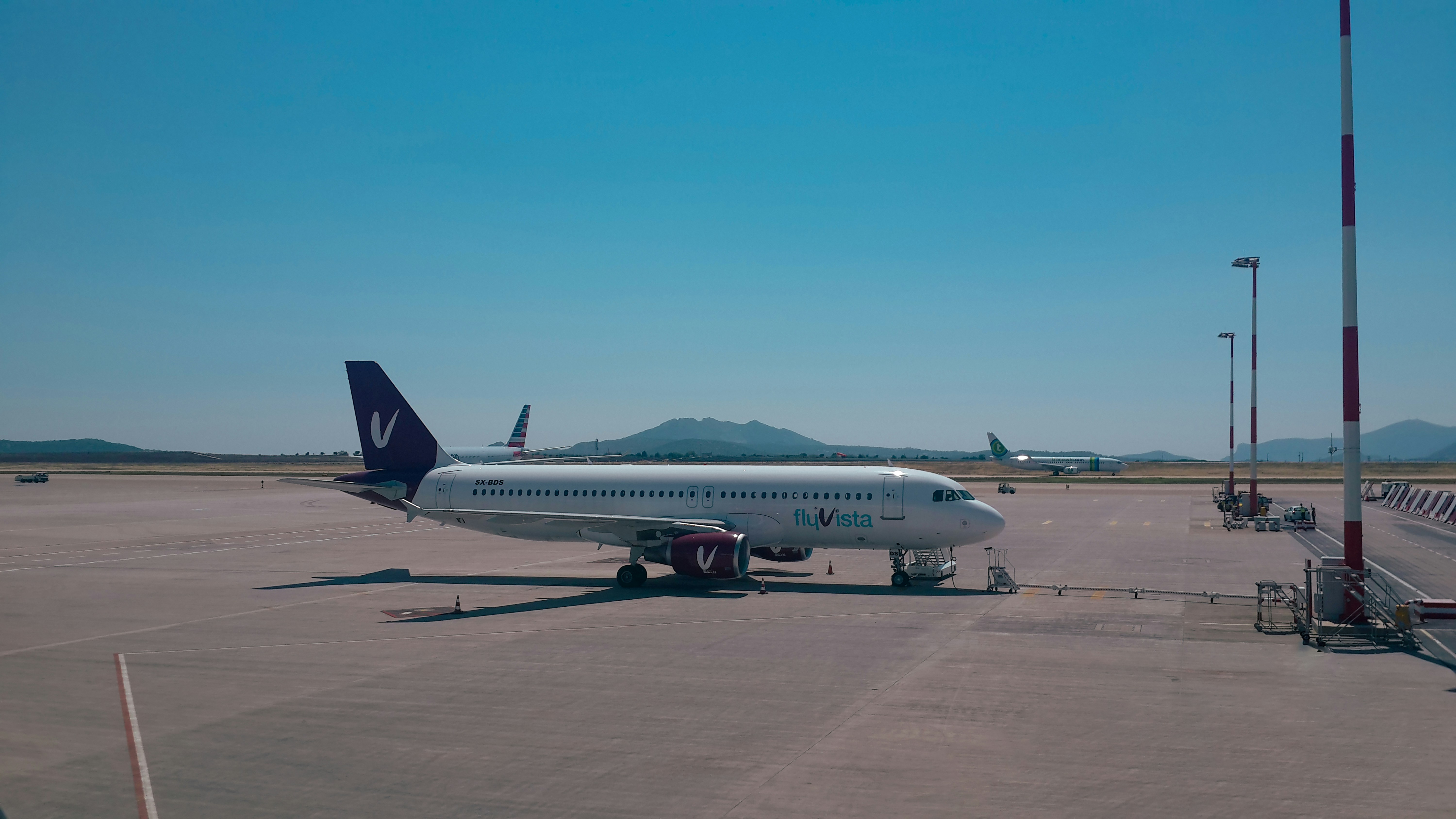 Fly Vista Airbus a320 at park position, Athens Airport | An airplane is parked on the tarmac.
