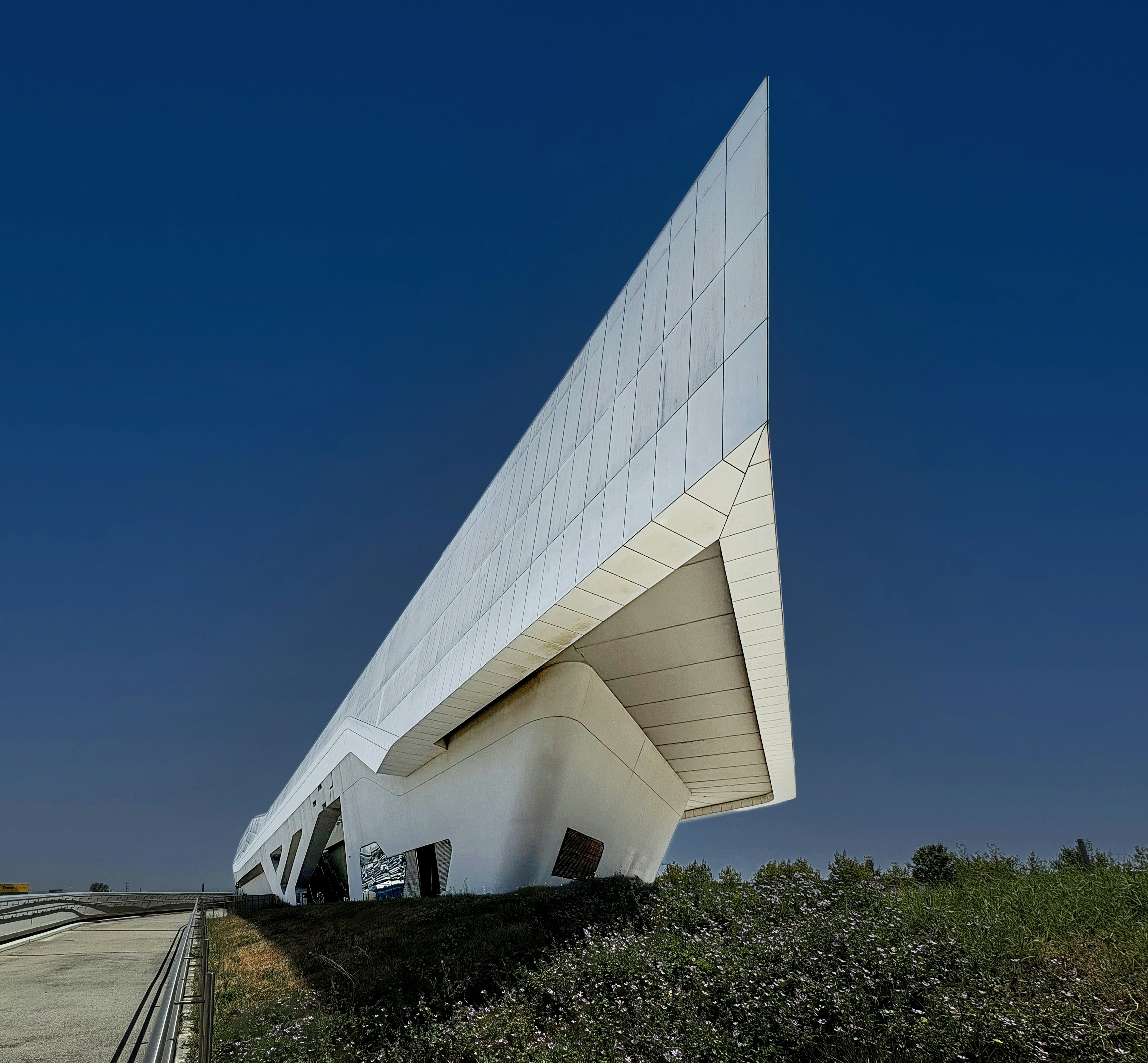 A modern, angular building reaches towards the sky.