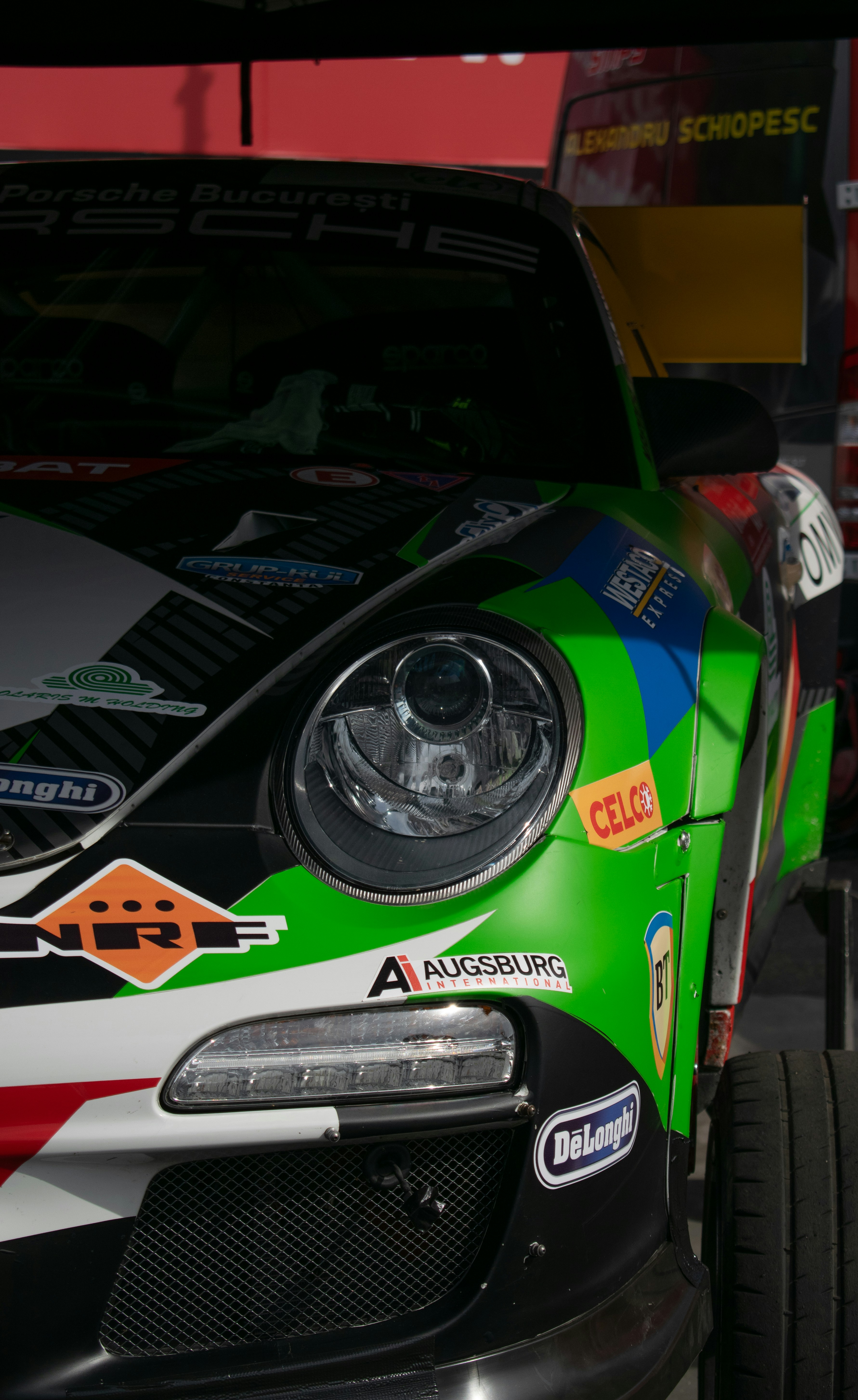 A green and black race car is displayed.