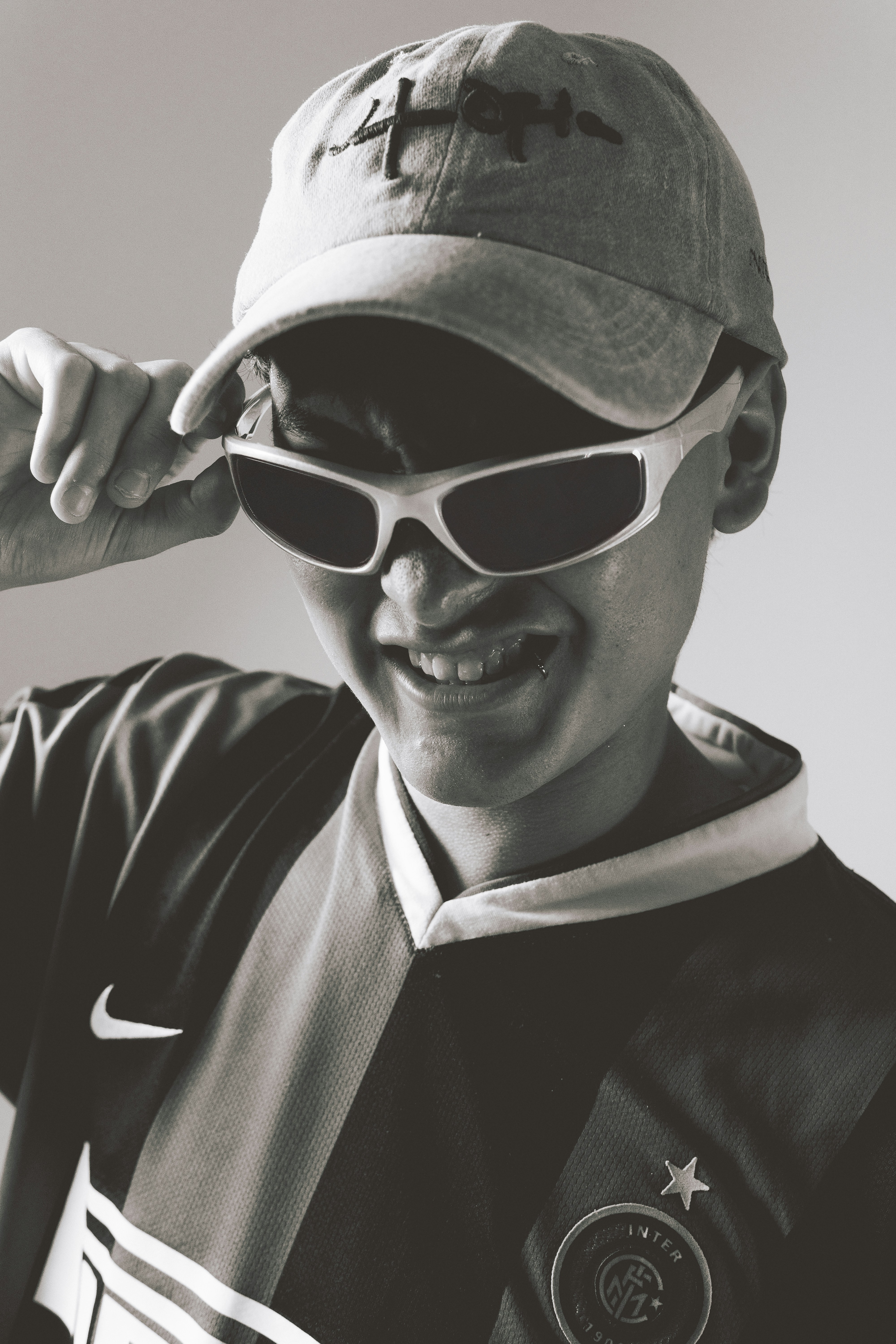 Monochrome Swagger: Teen in Cap and Sunglasses with Inter Milan Jersey