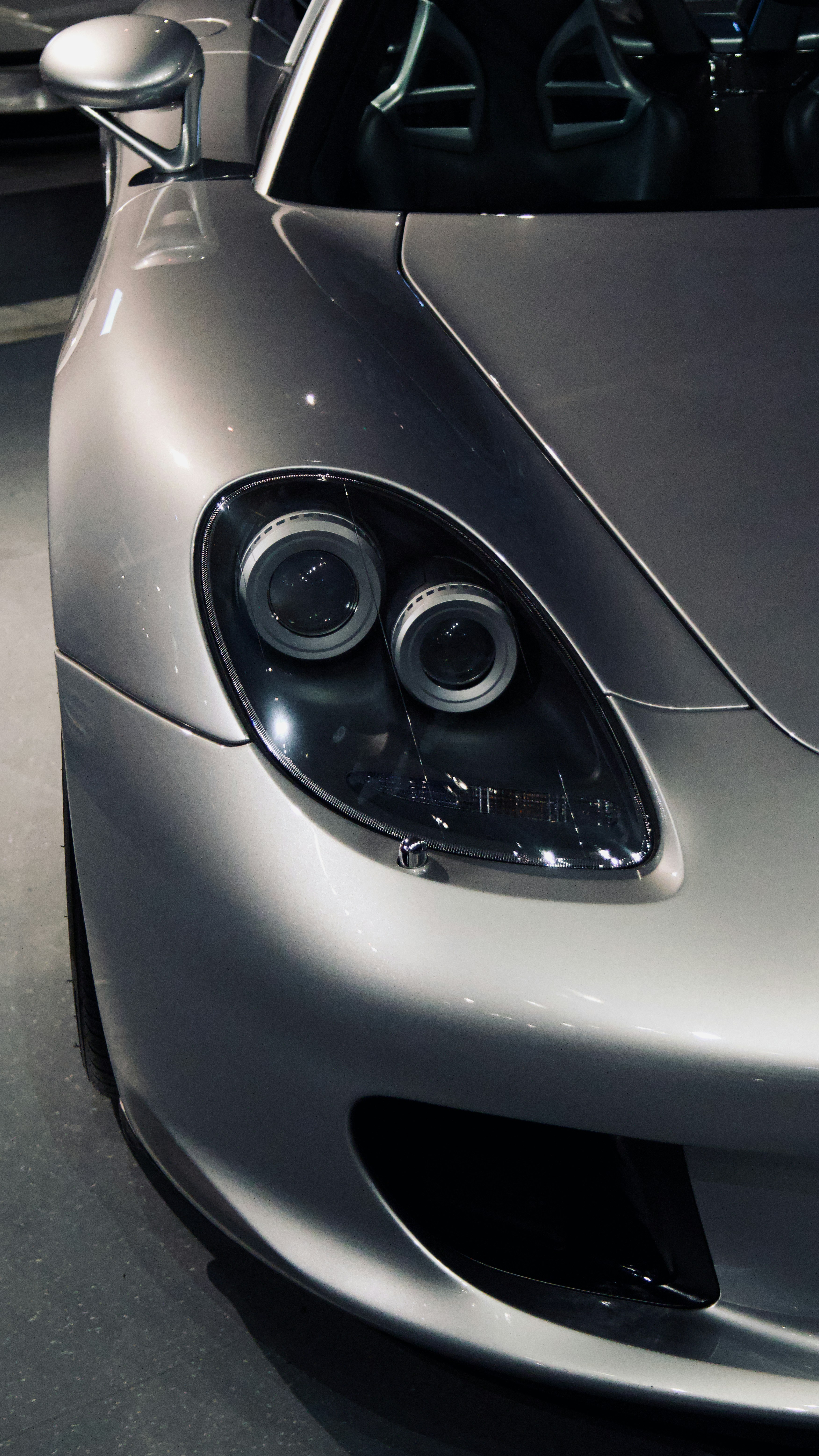 A silver sports car's front view.