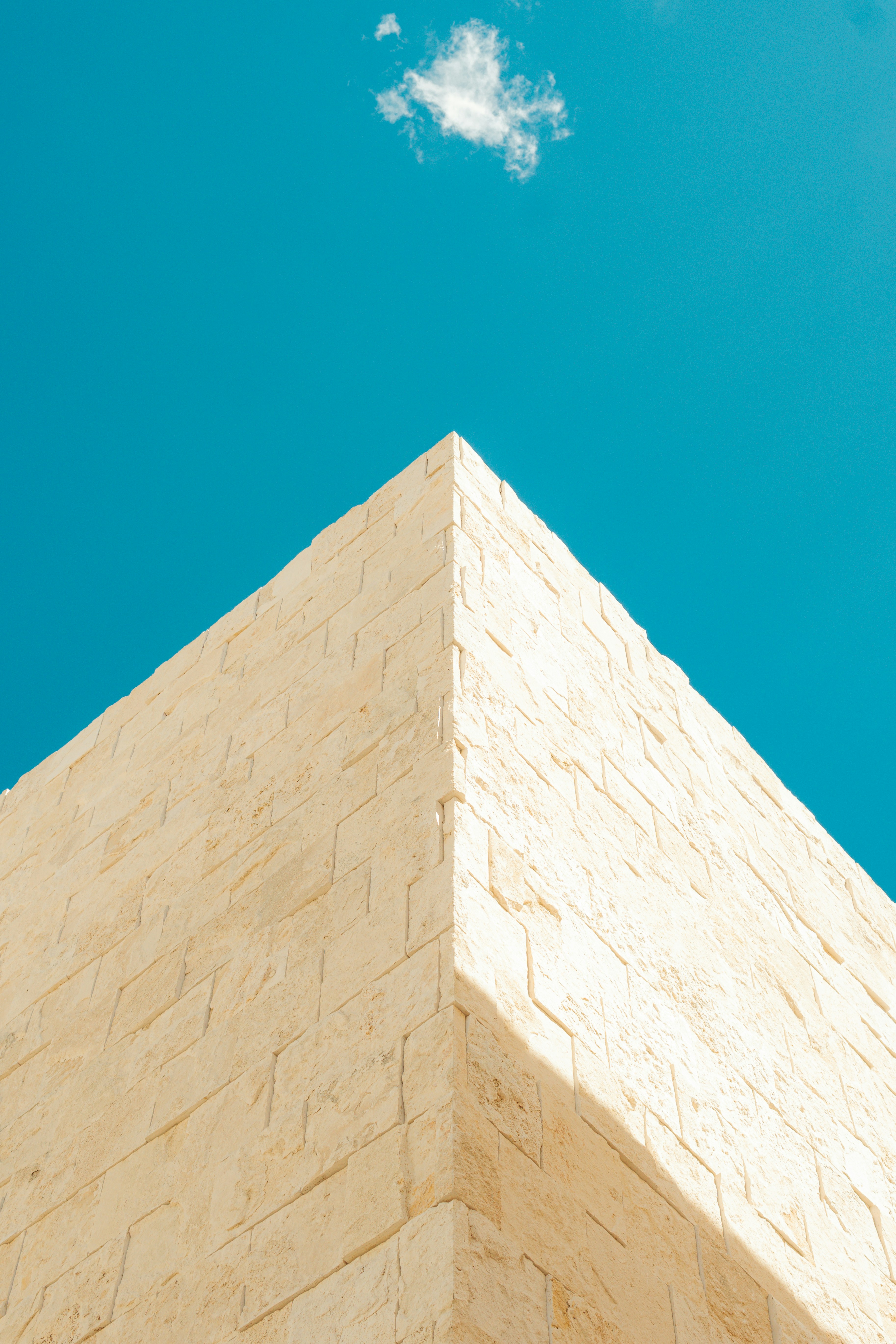 A corner of a building against a clear blue sky.