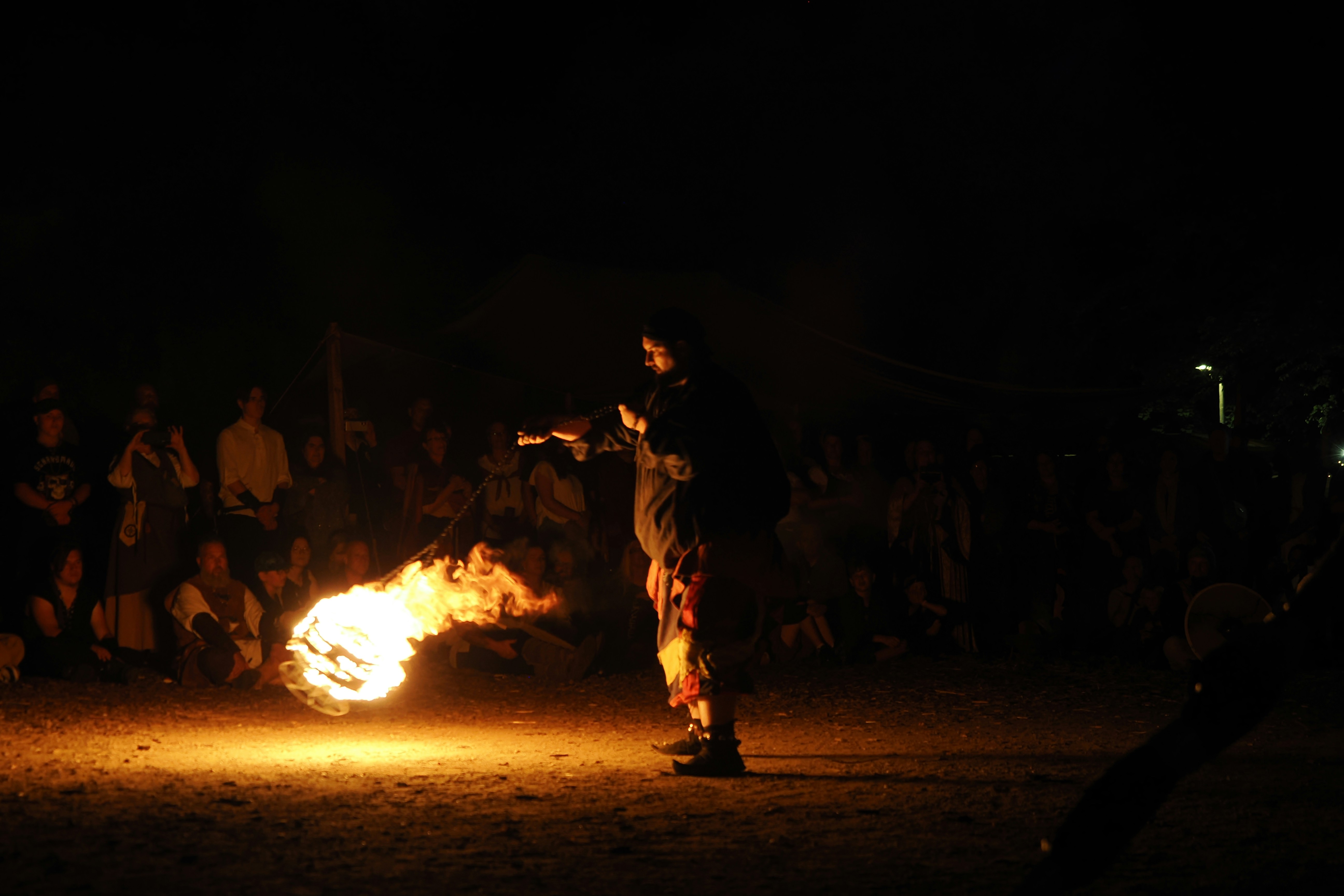 Nightfire in the Circle: A Fire Performer Lights the Night Crowd
