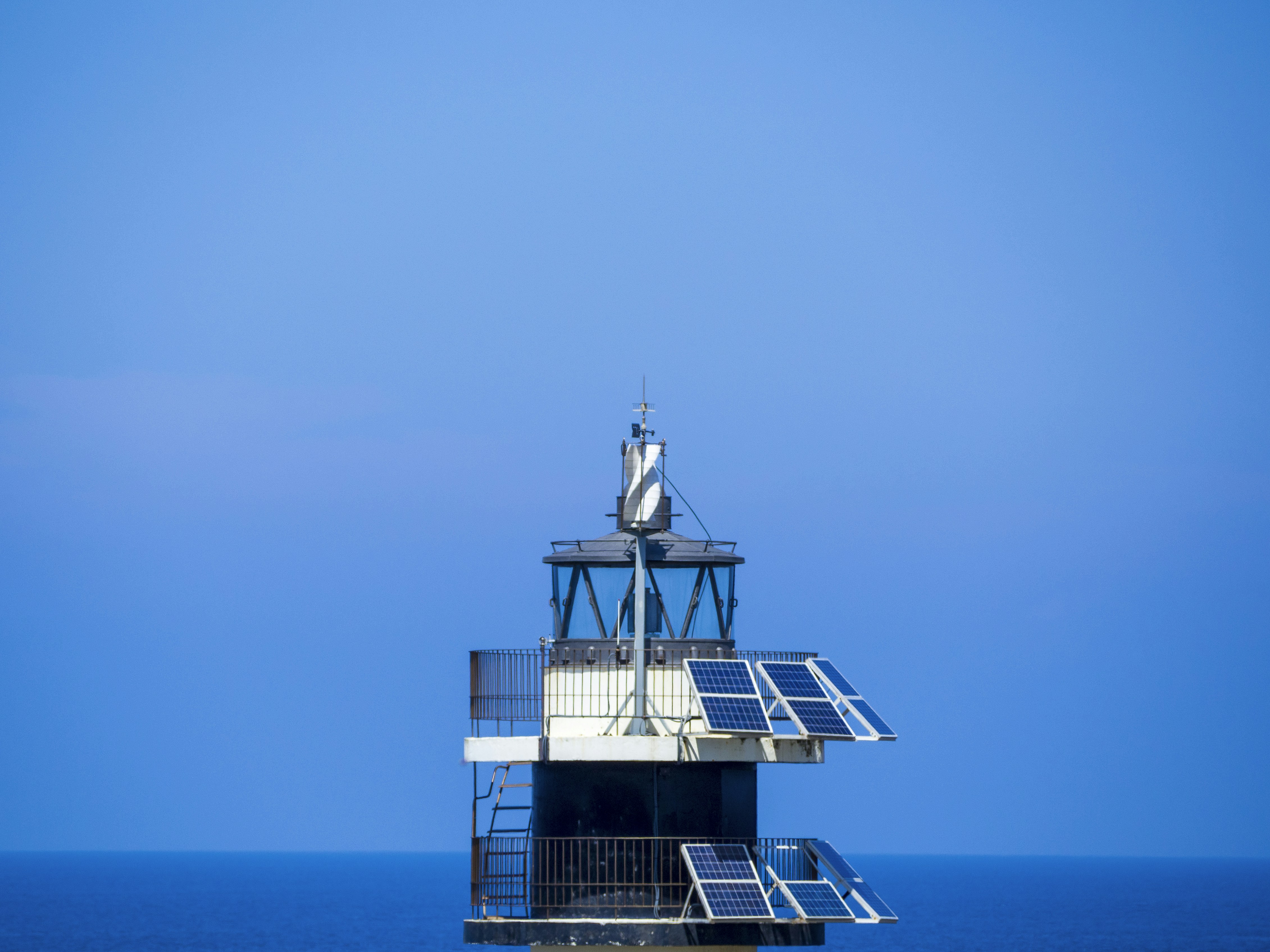 OLYMPUS DIGITAL CAMERA | A modern lighthouse floats upon the sea.