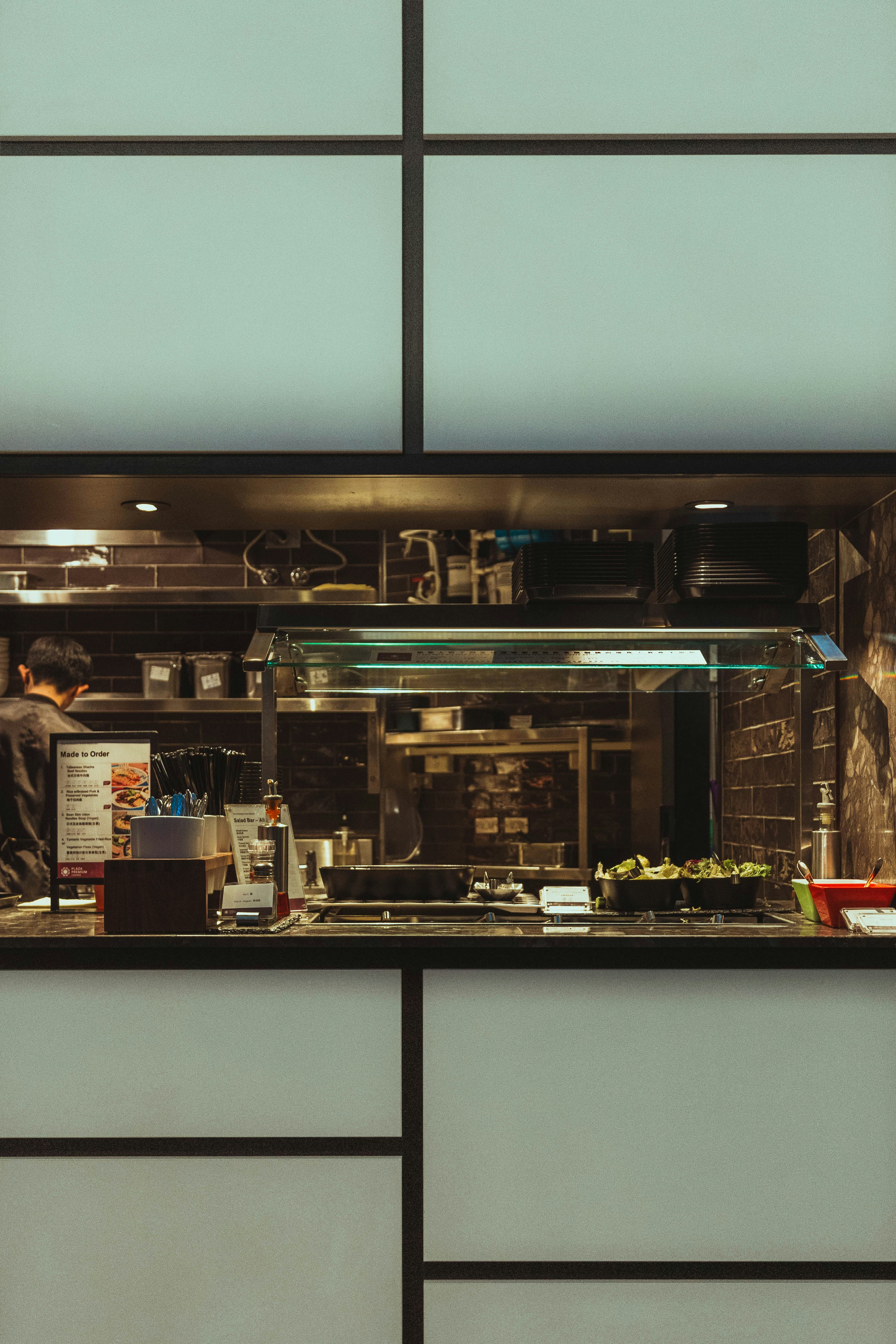 Restaurant counter and kitchen interior.