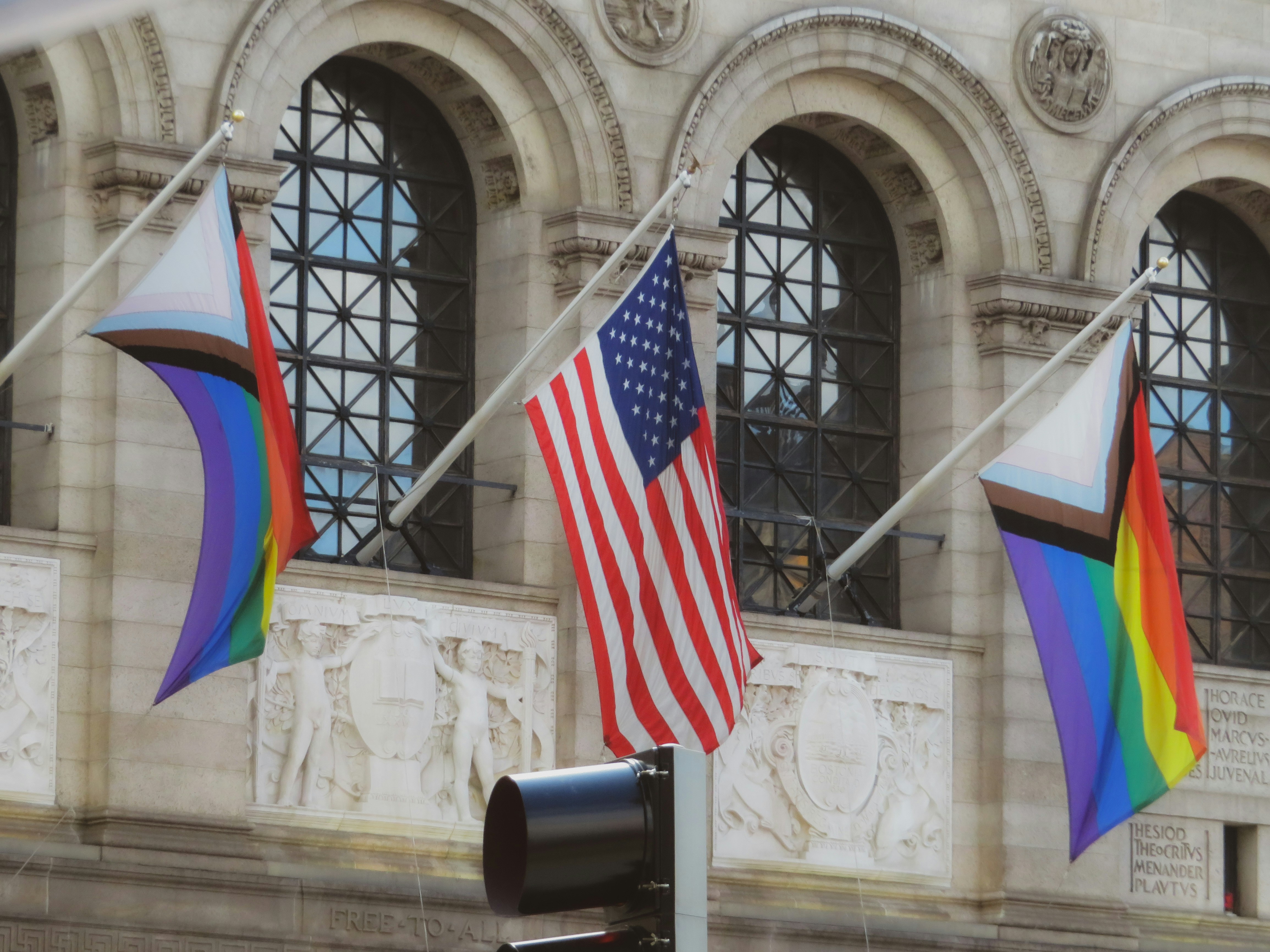 Flags of pride and the usa are displayed.