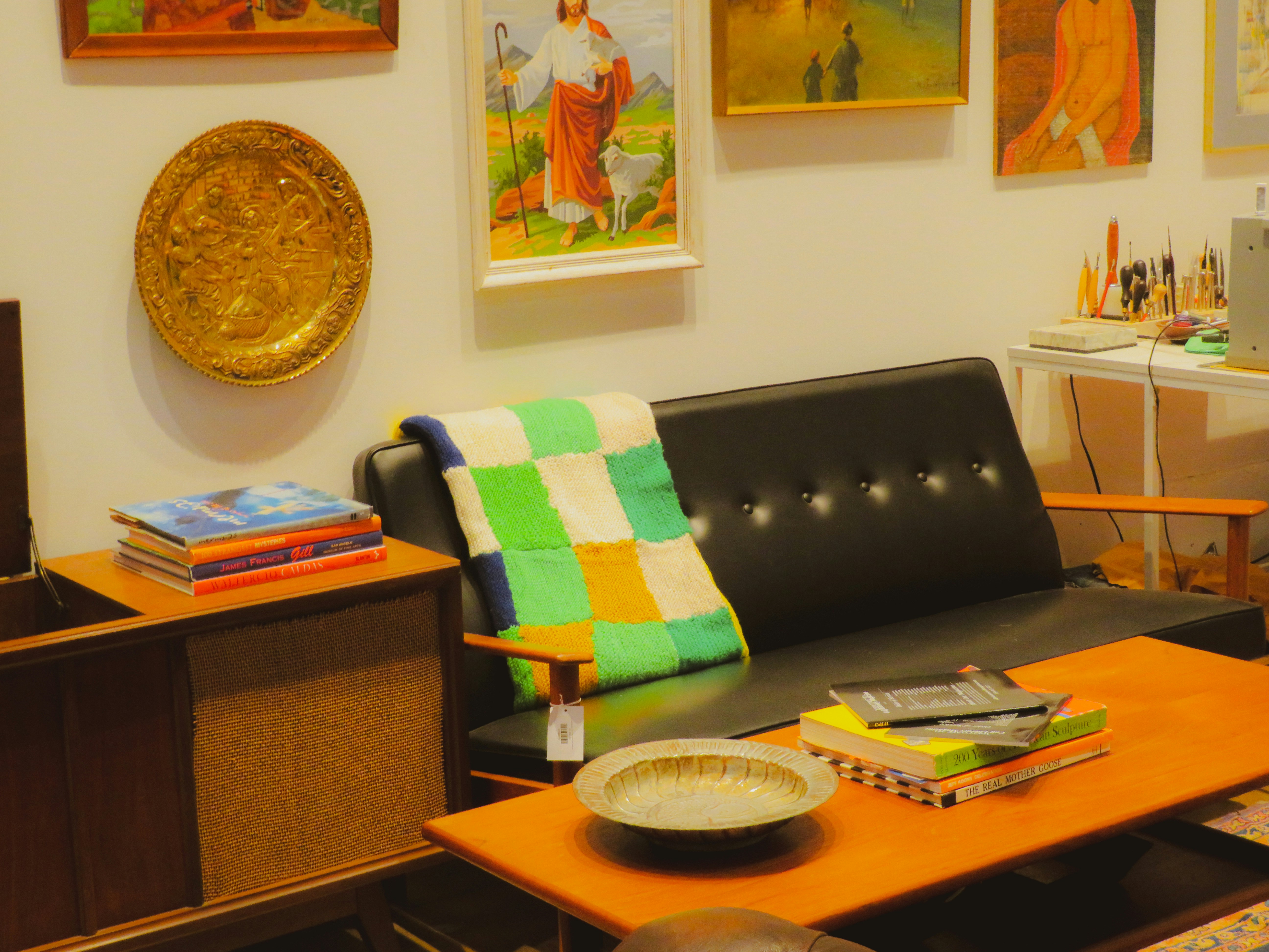 A living room is filled with artwork and furniture.