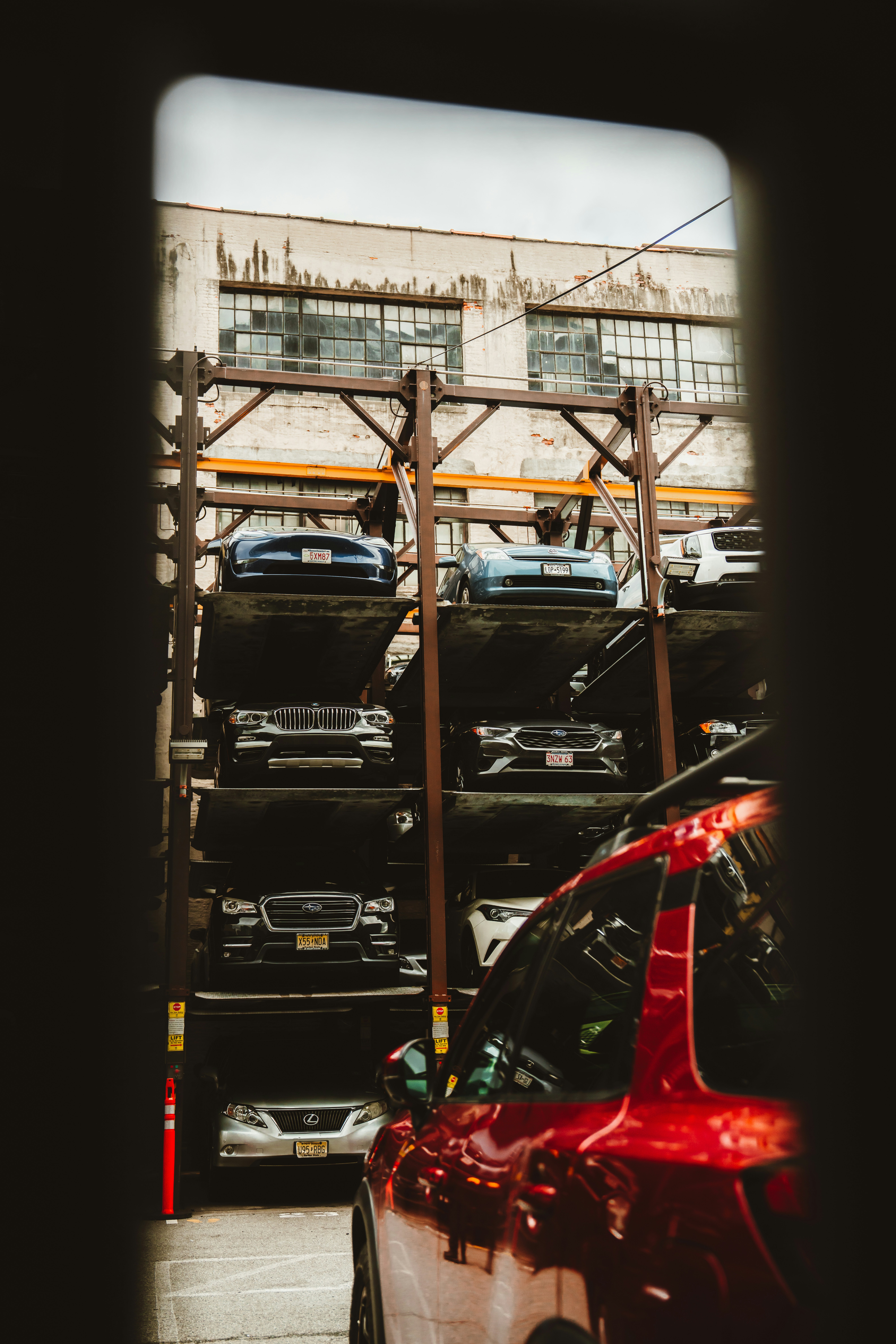 Cars are stacked in a multi-level parking structure.