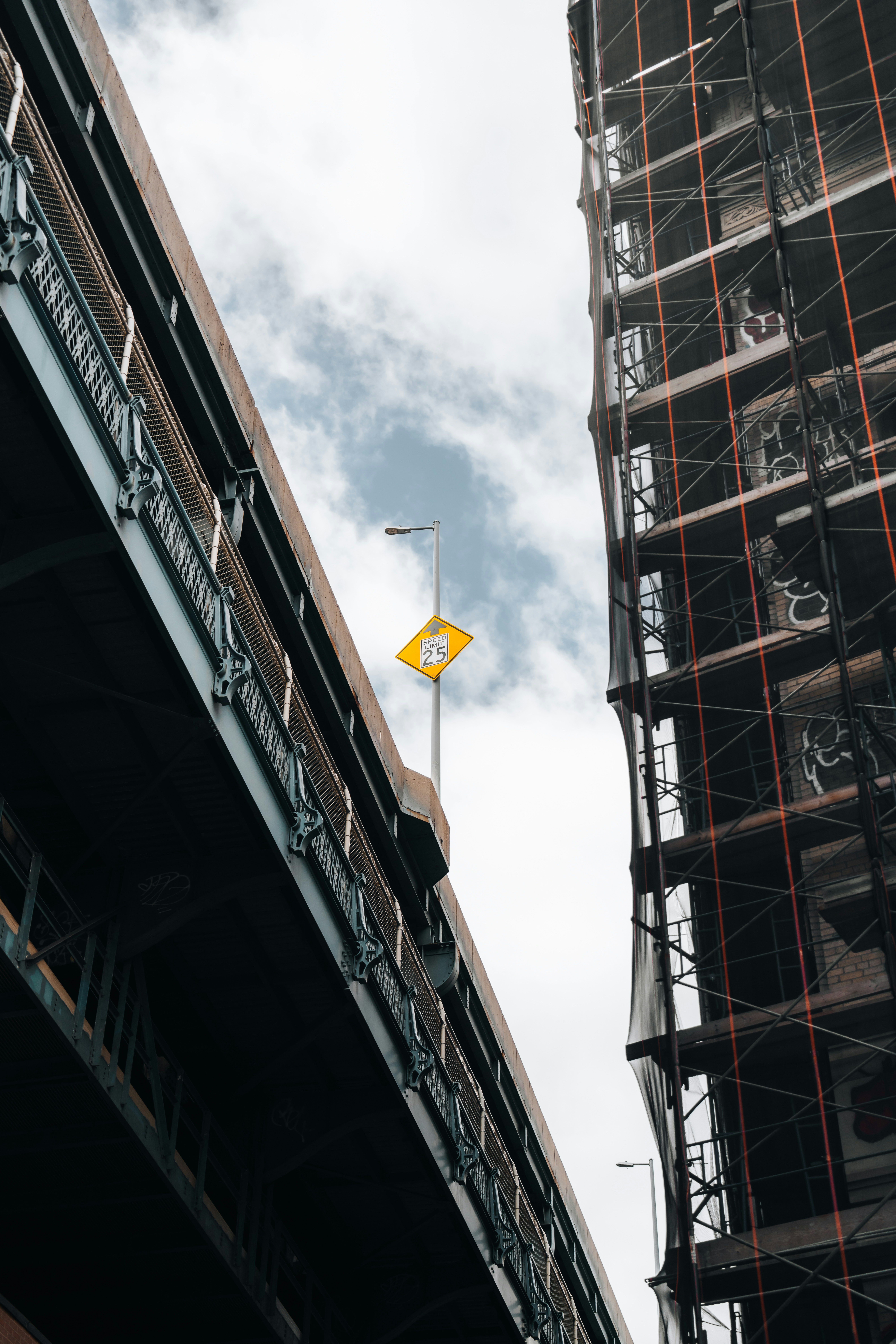 Bridge and building are juxtaposed against the sky.