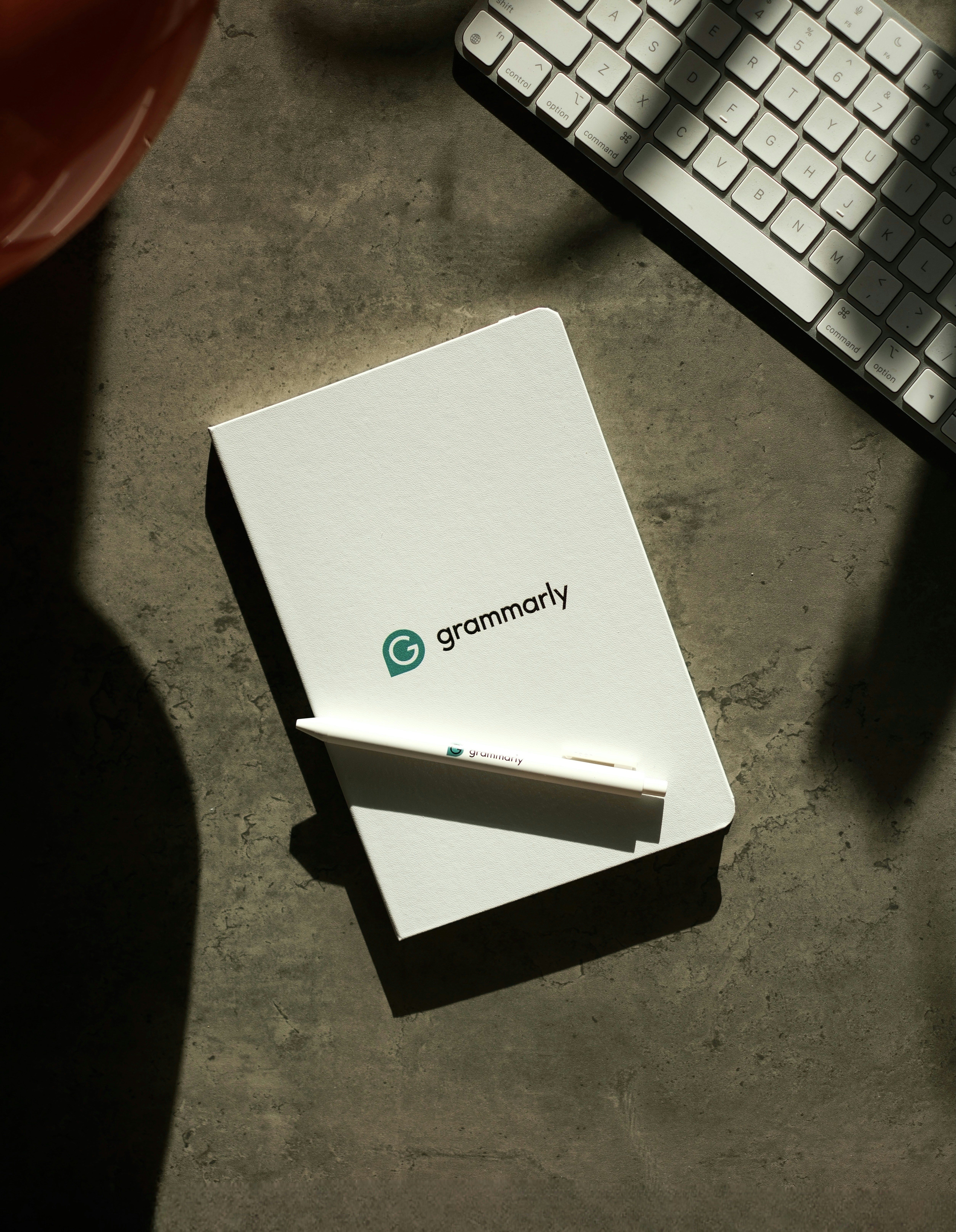 Grammarly notebook, pen, and keyboard on a desk. photo – Free Wallpaper ...