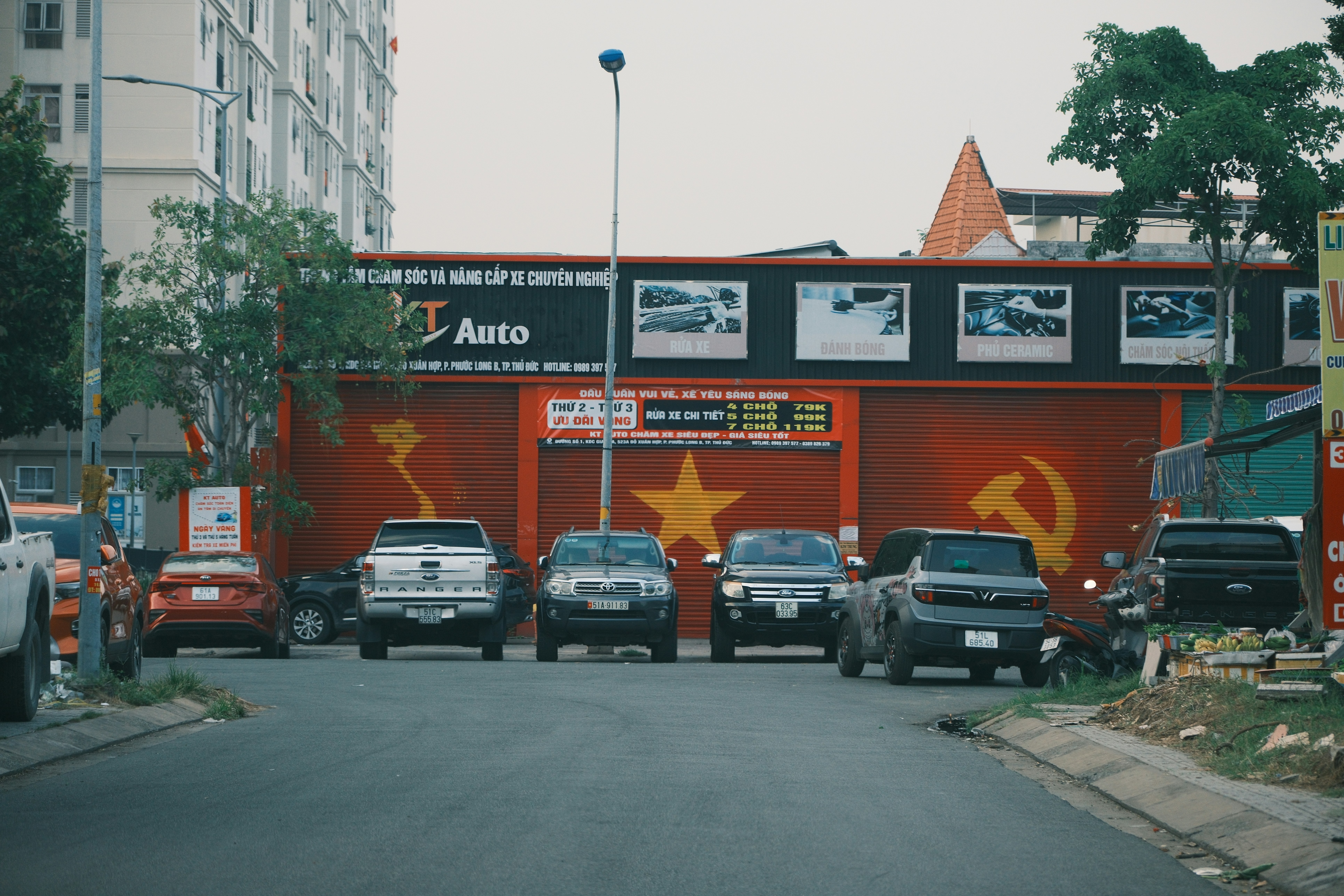 Cars parked in front of a building with communist symbols.