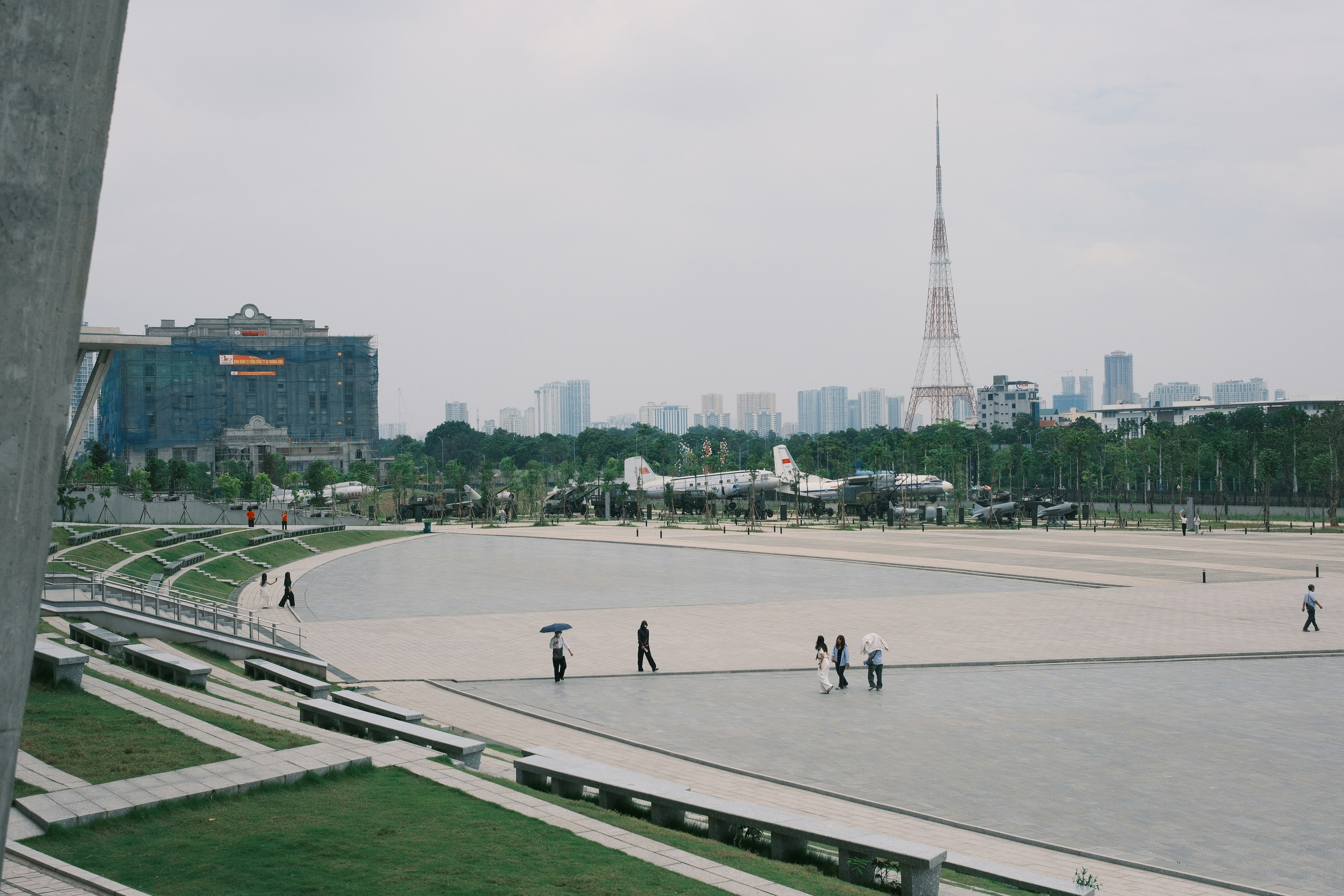 Park with an airplane and city skyline.