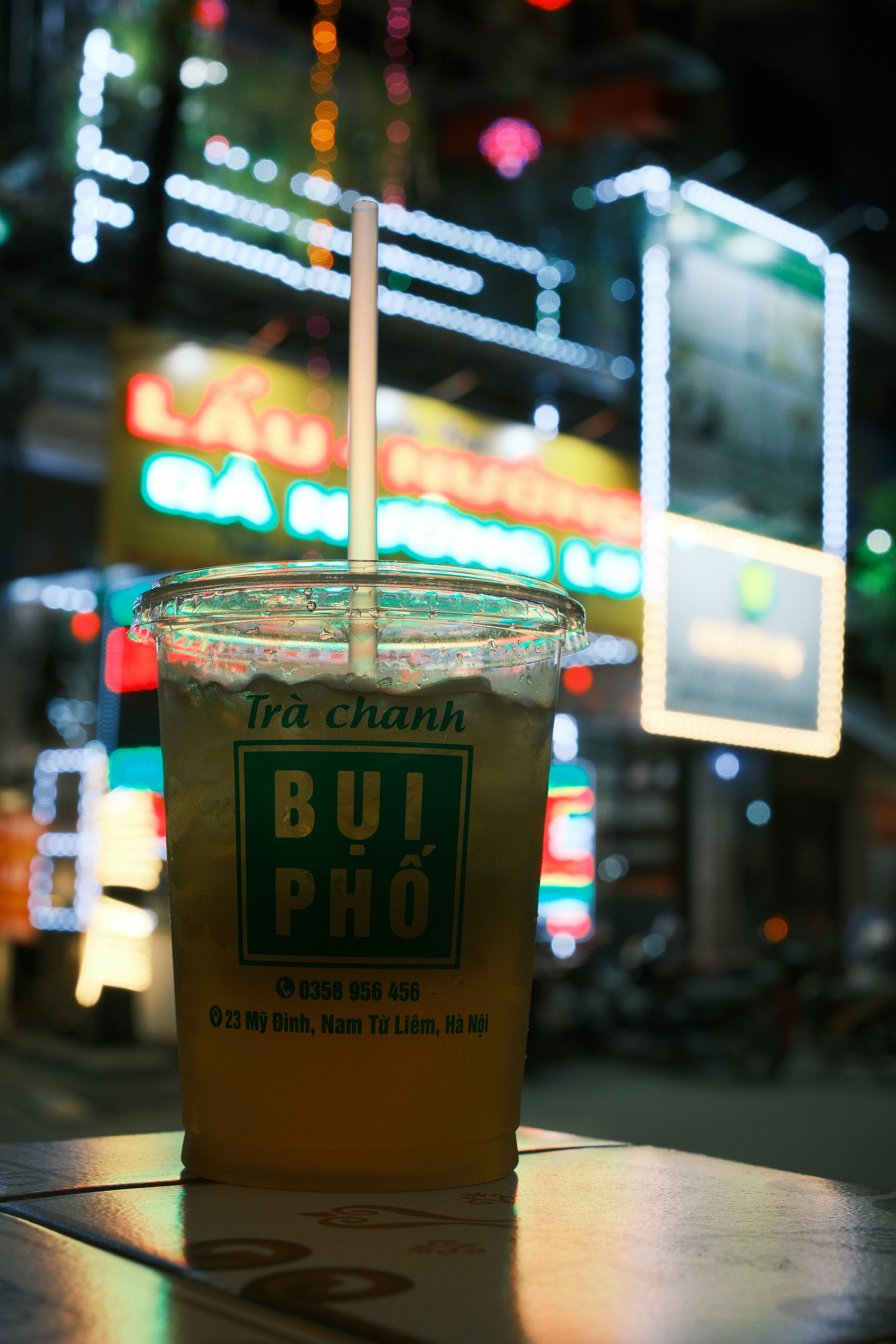 Iced tea in a city at night.