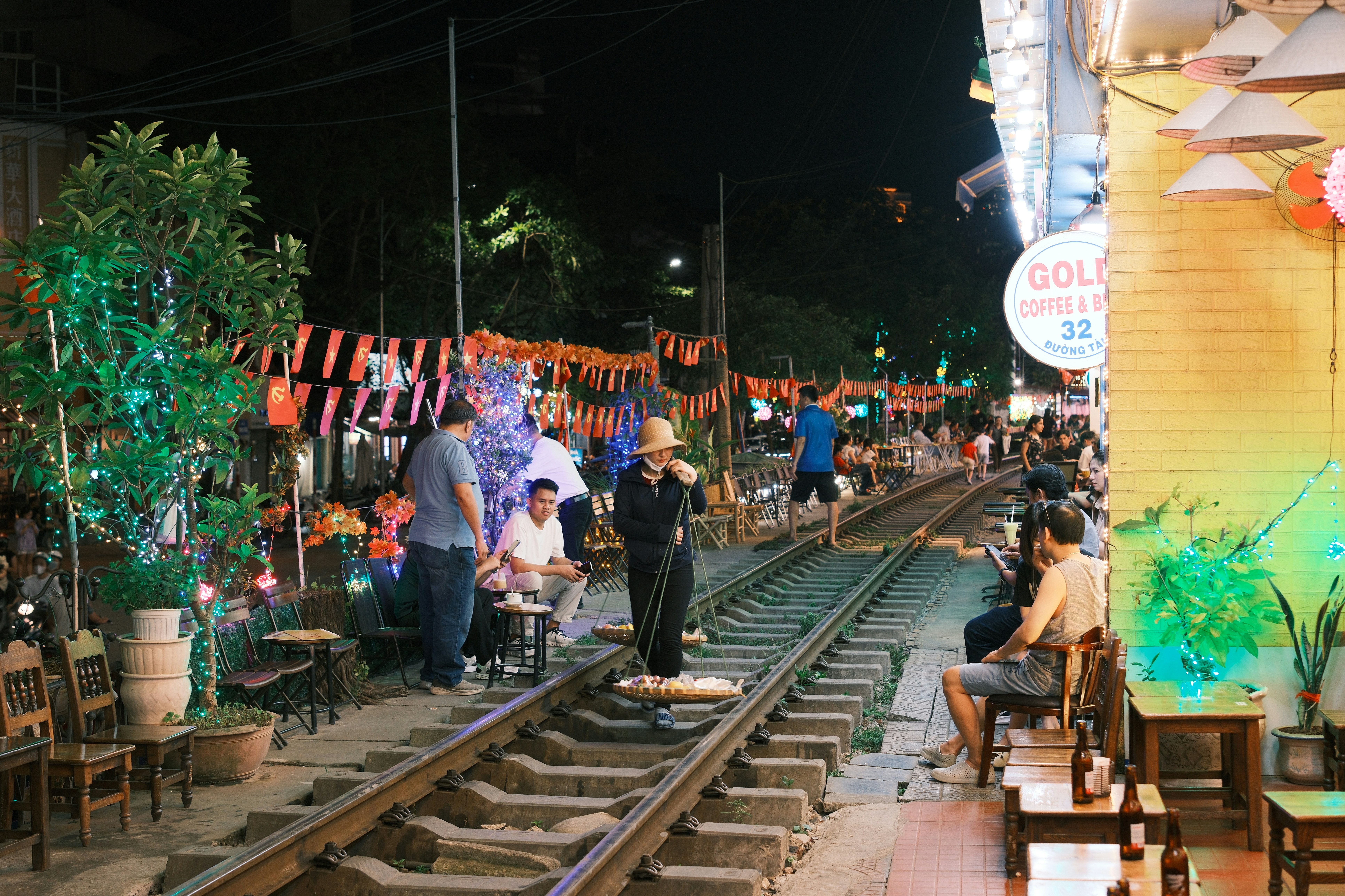 Railway Café at Night: Lanterns, Tracks, and Toasted Smiles