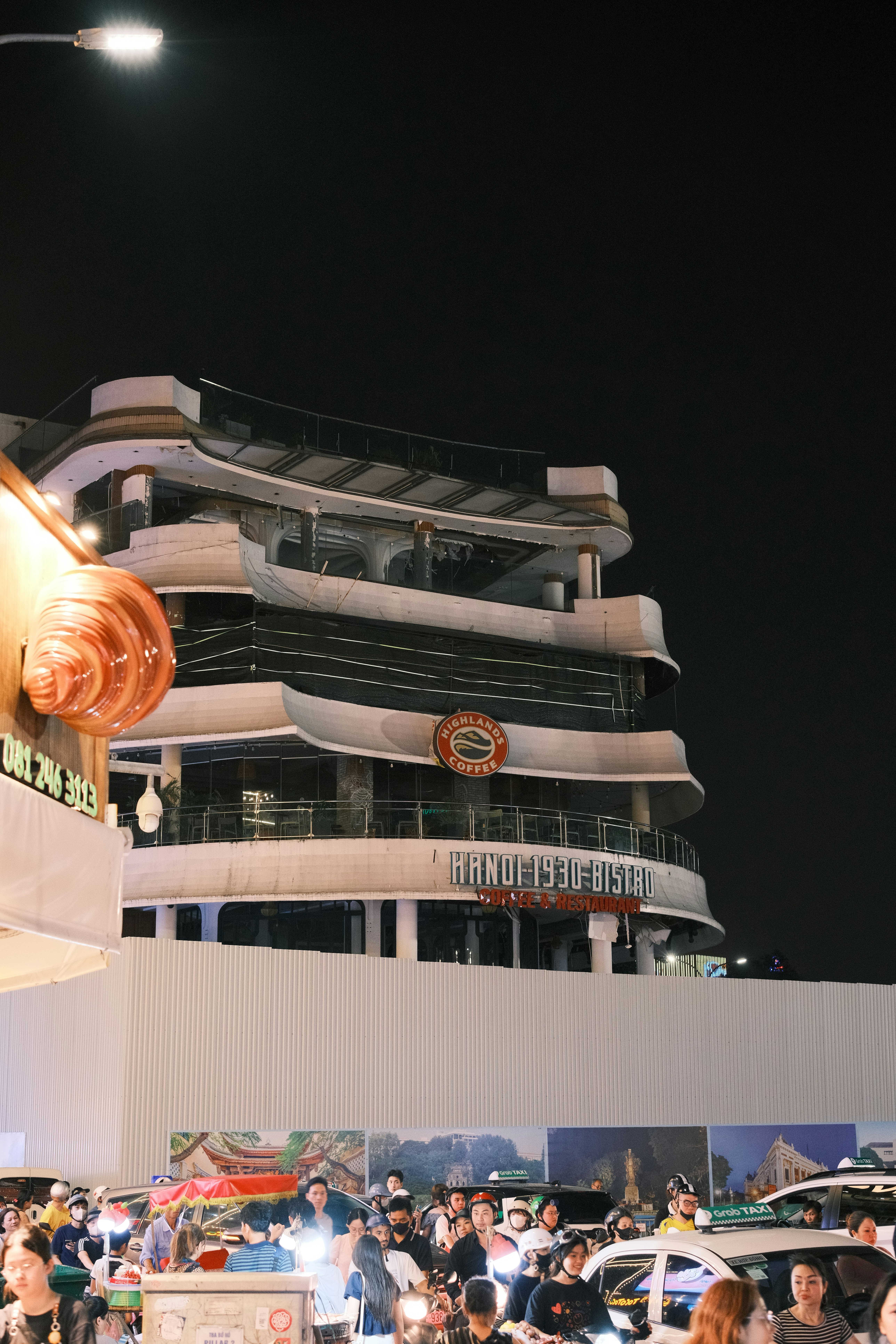 Night Spiral: A Curved Modernist Coffee Tower Bathed in City Lights