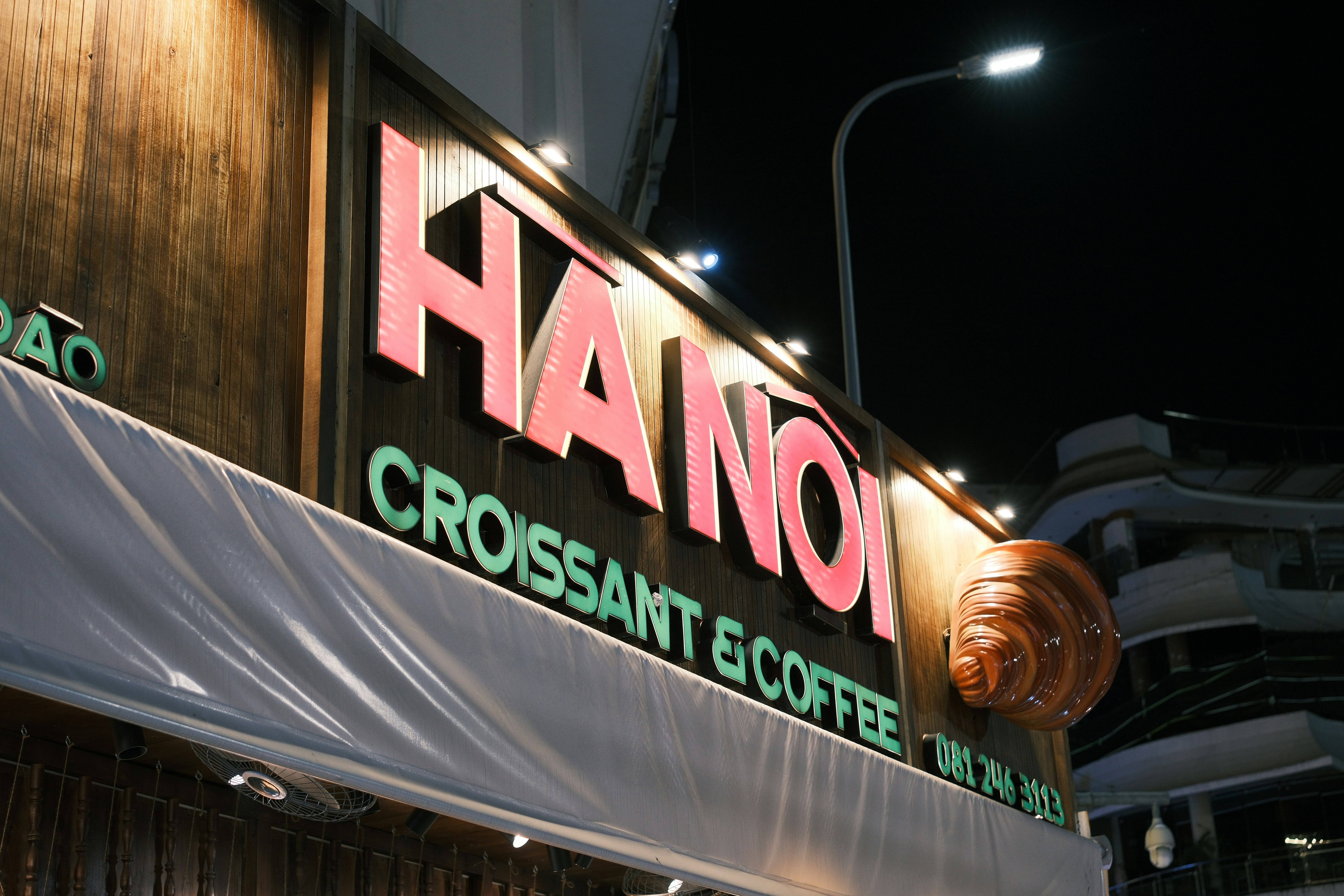 Hanoi Neon Signage at Night: Croissant & Coffee Under Pink Letters