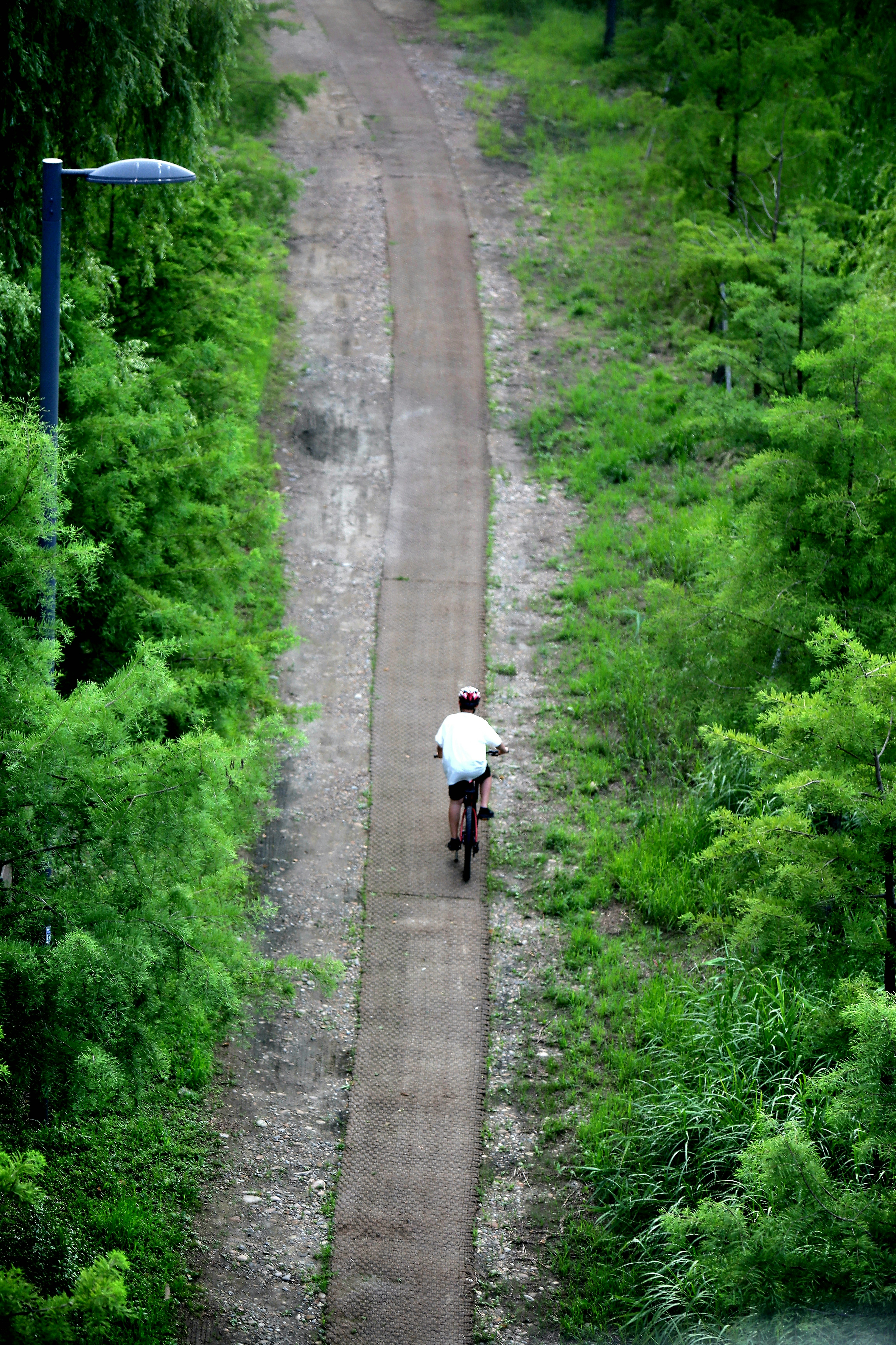 A person rides a bike along a path.