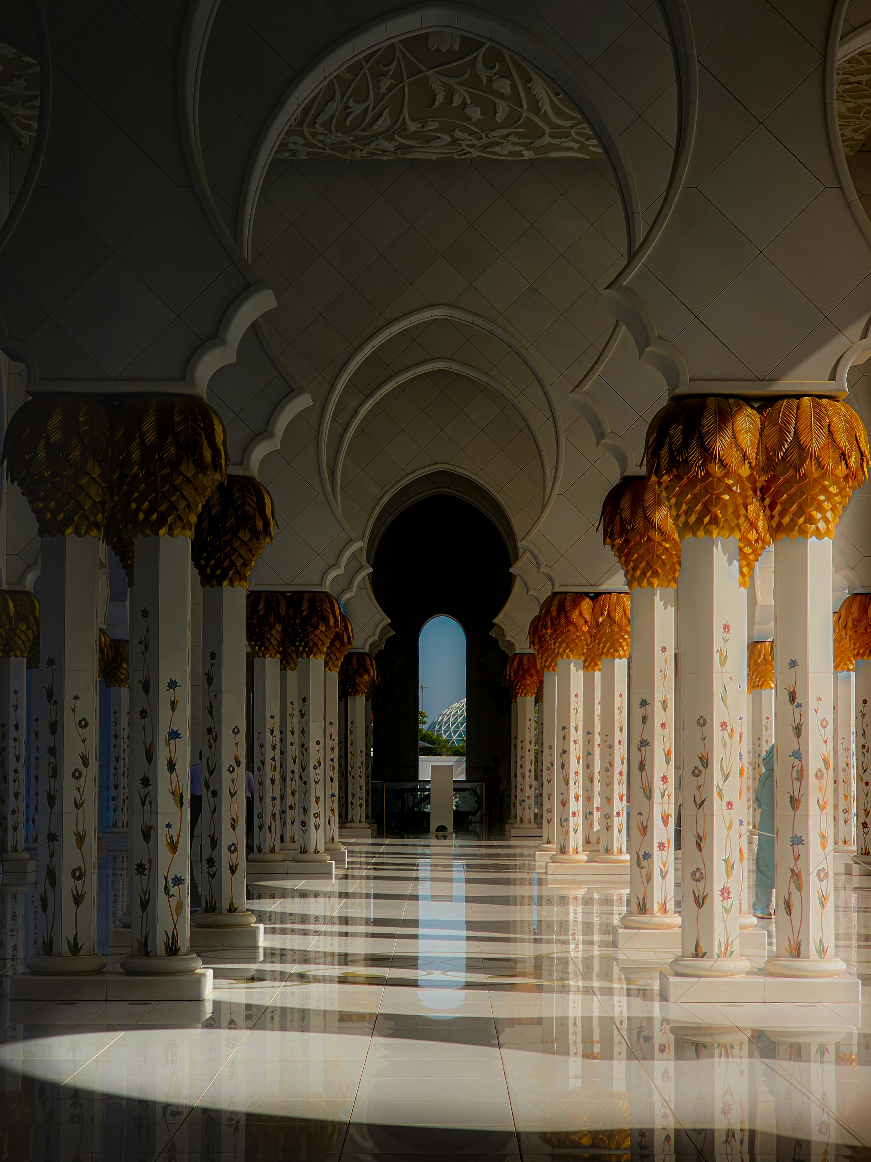 Inside a stunning mosque with ornate pillars and arches.