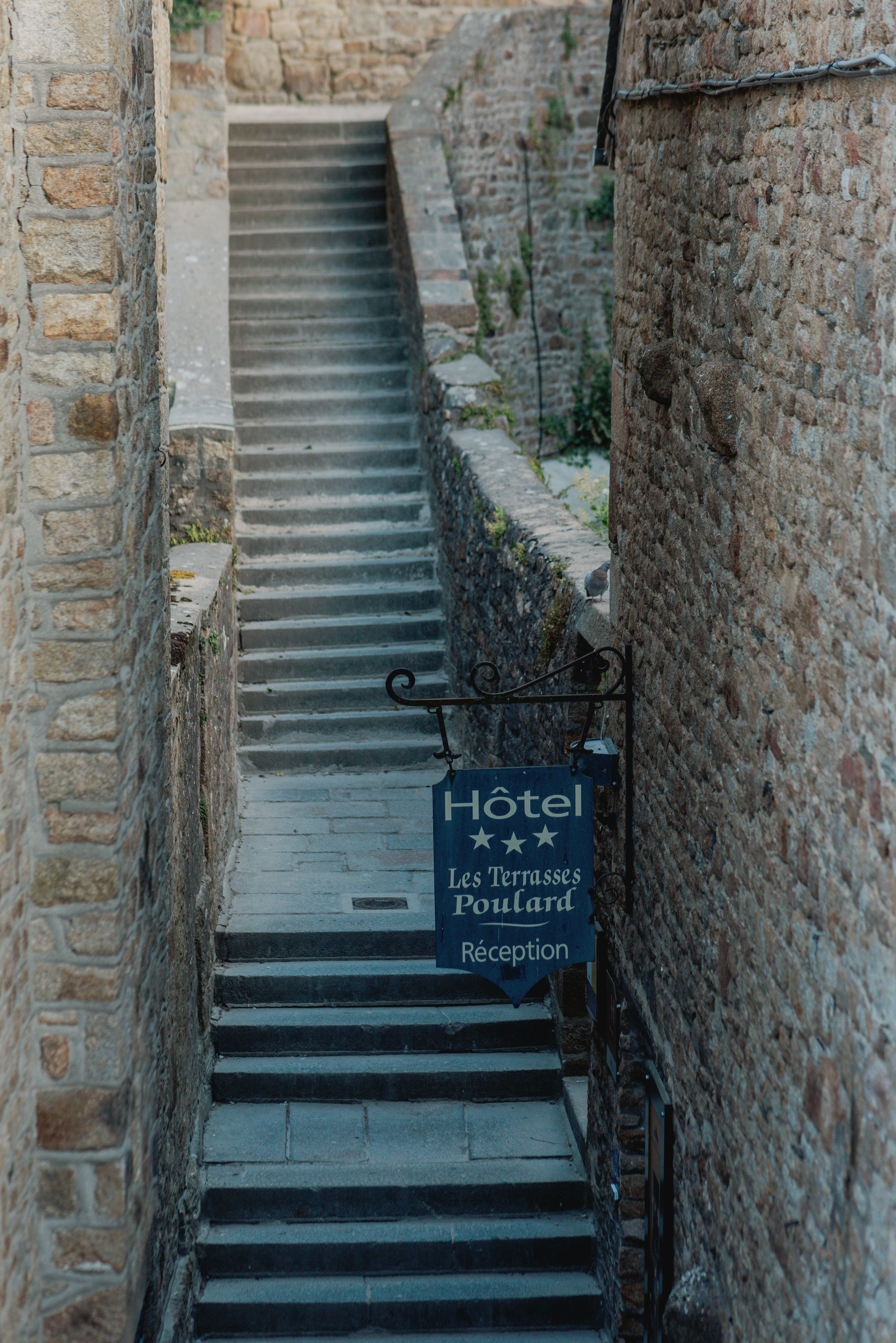 A stone staircase leads up toward a hotel.