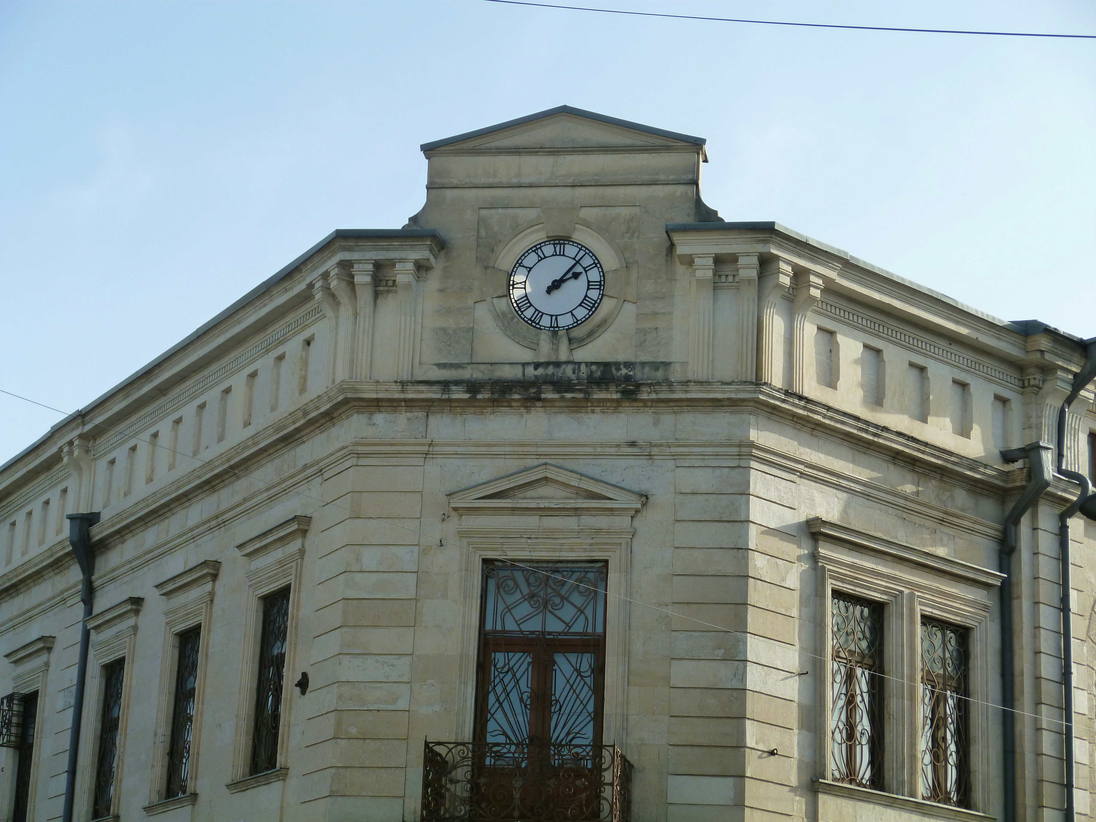Clock tower on a corner of an old building.