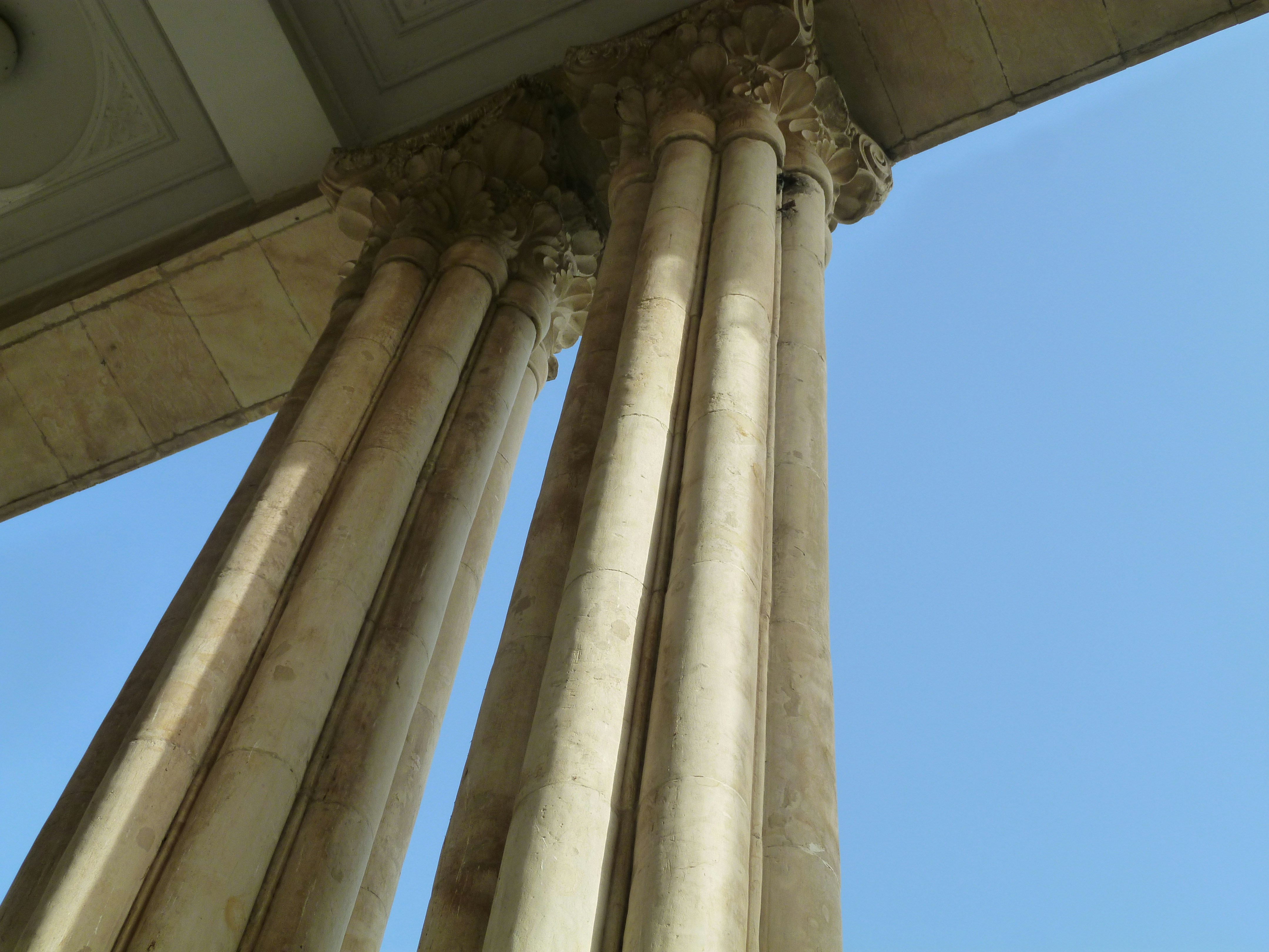 Columns of a building against the blue sky.