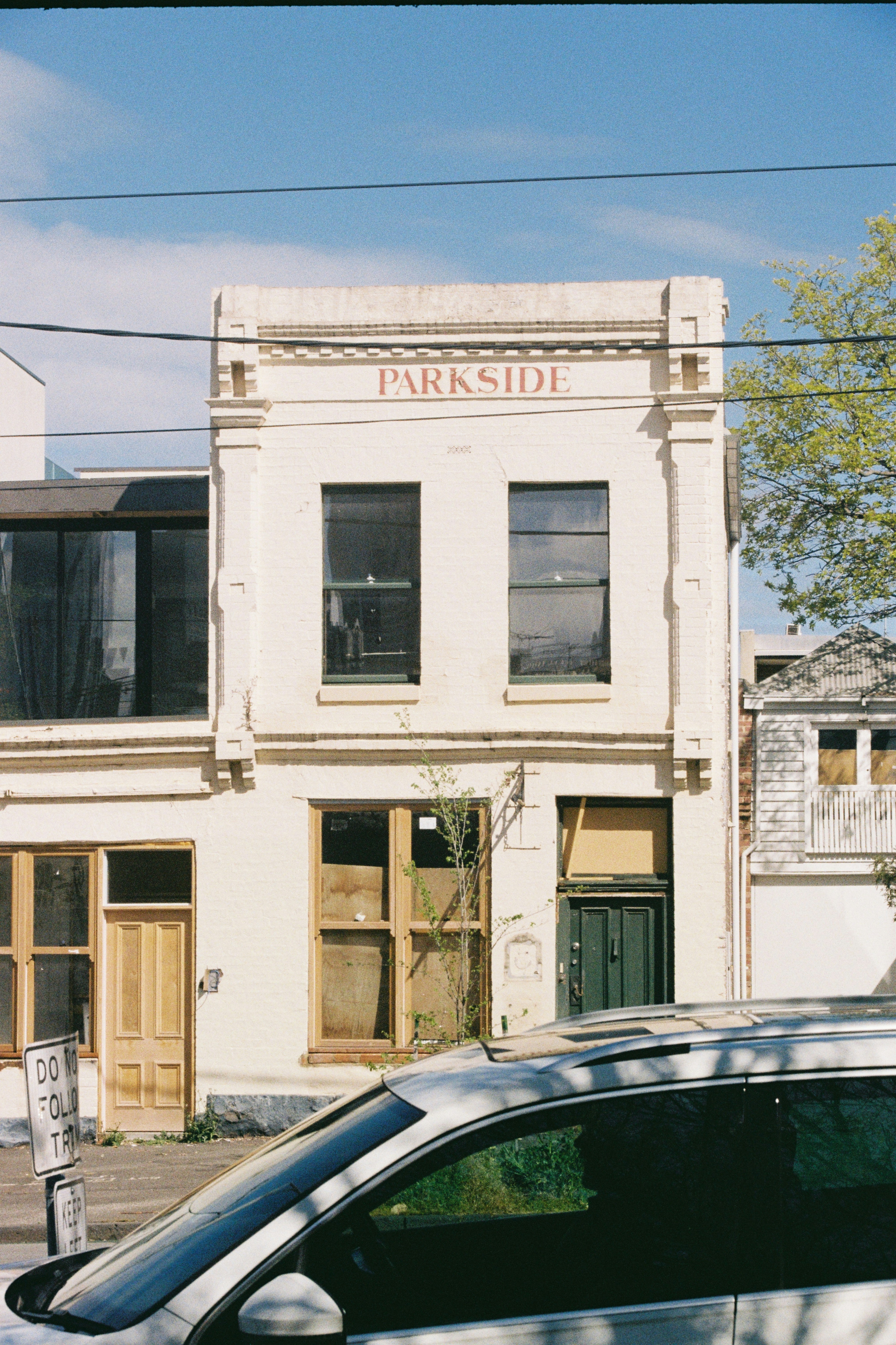 Architecture on the street of Melbourne | A dilapidated building labeled "parkside" on its facade.