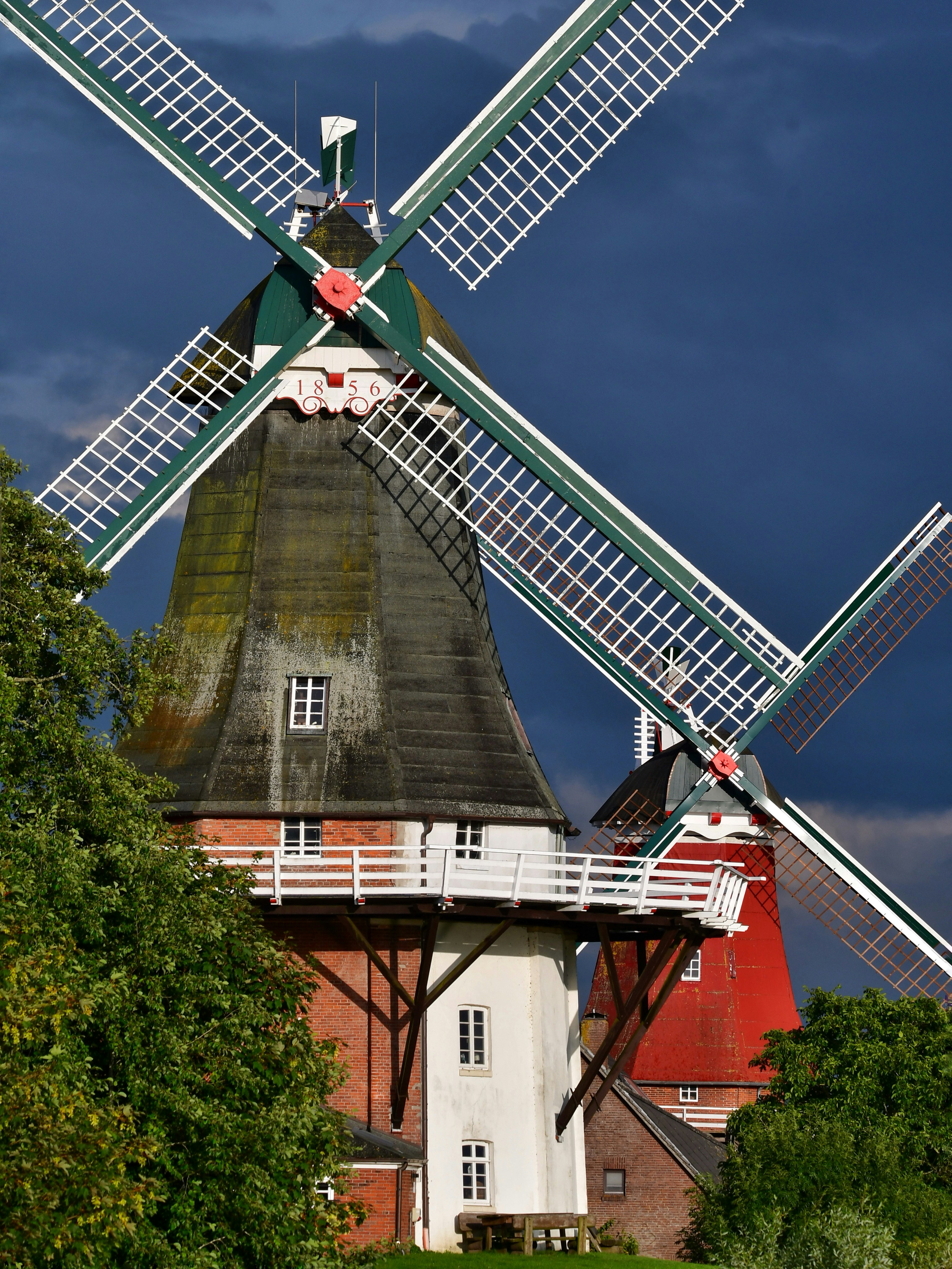 Towering Blades: A Windmill Portrait Against Stormy Skies