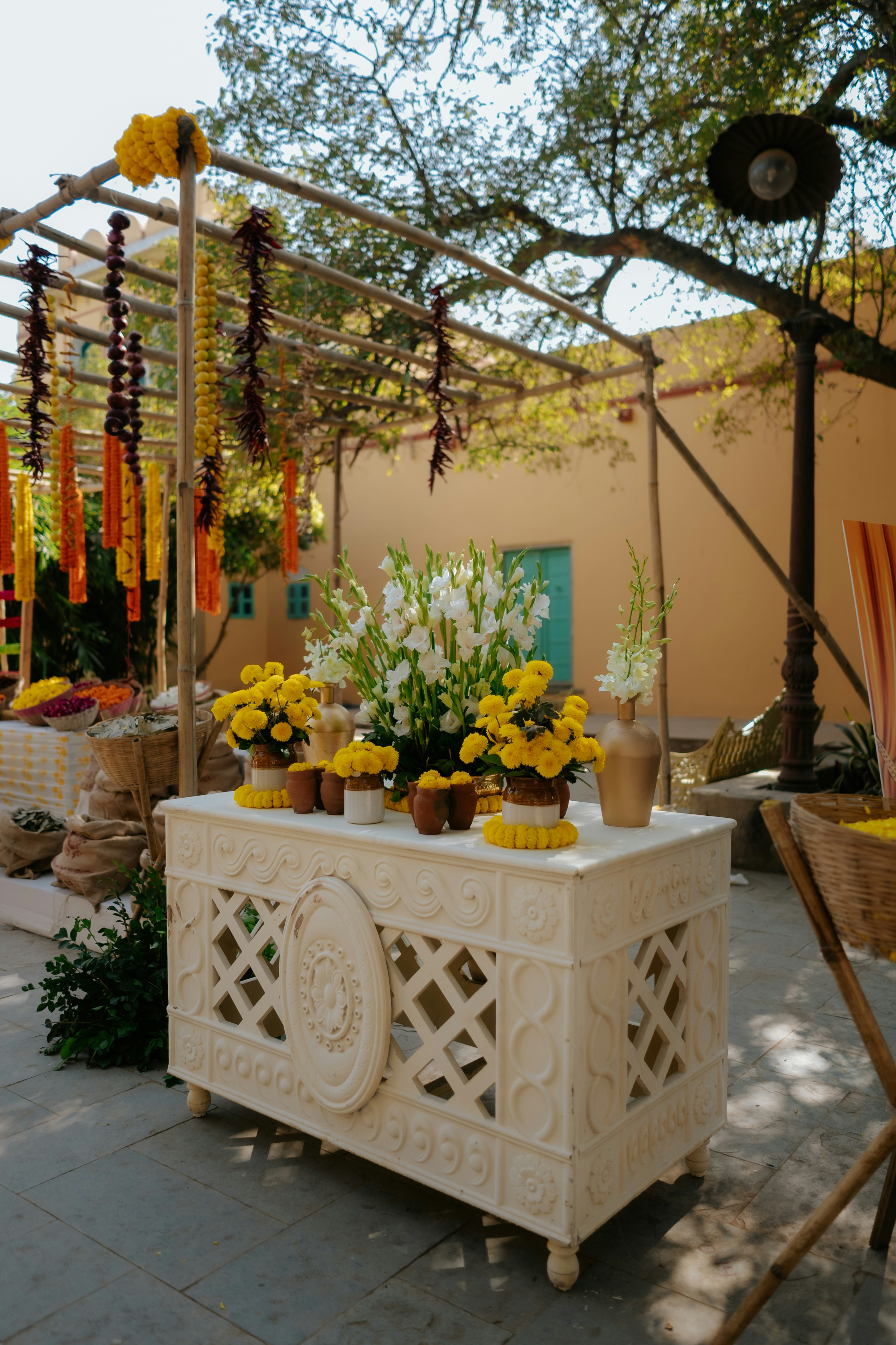 Sunlit Market Altar: Floral Display on an Ornate White Table