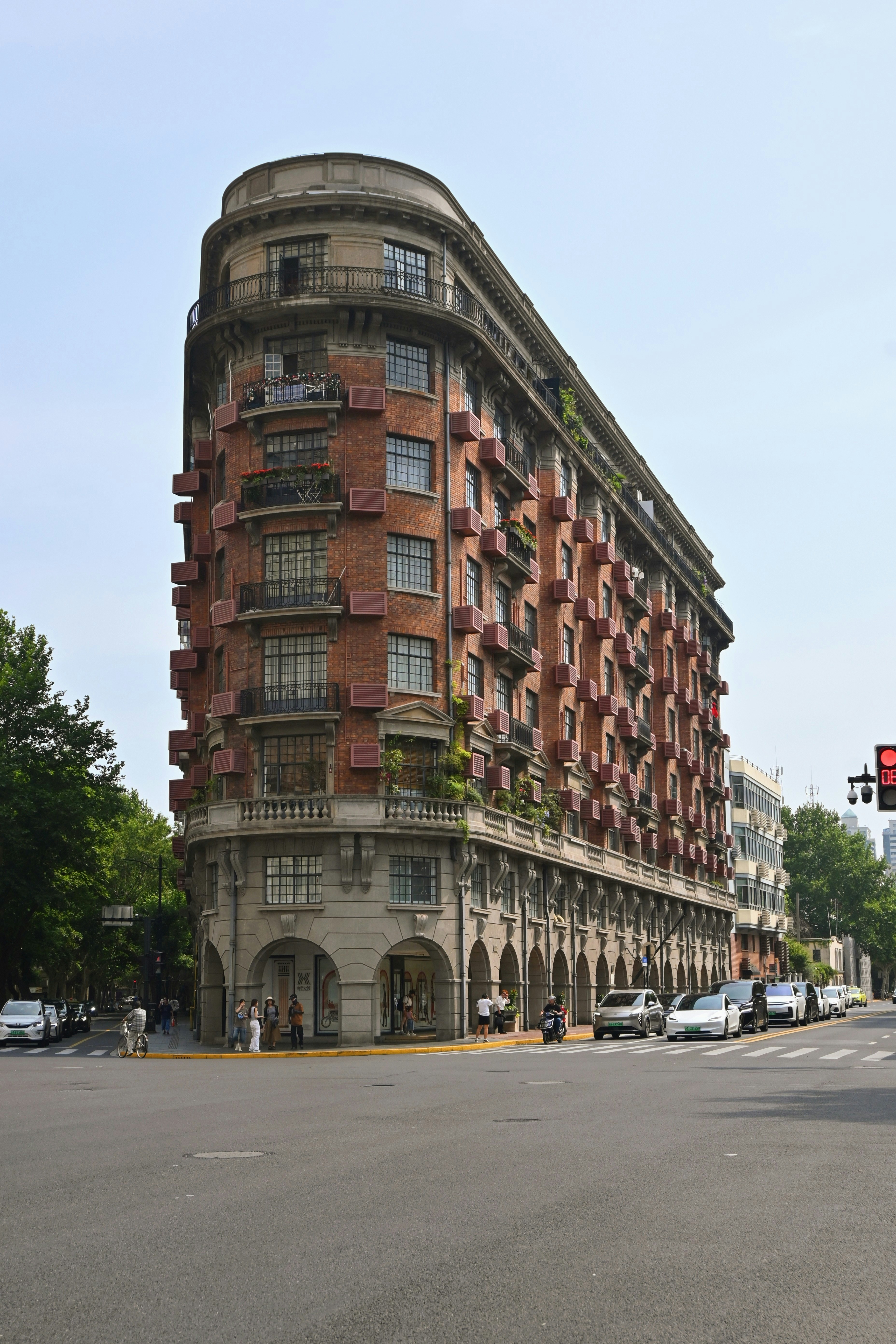 An old, unique building stands at a busy intersection.