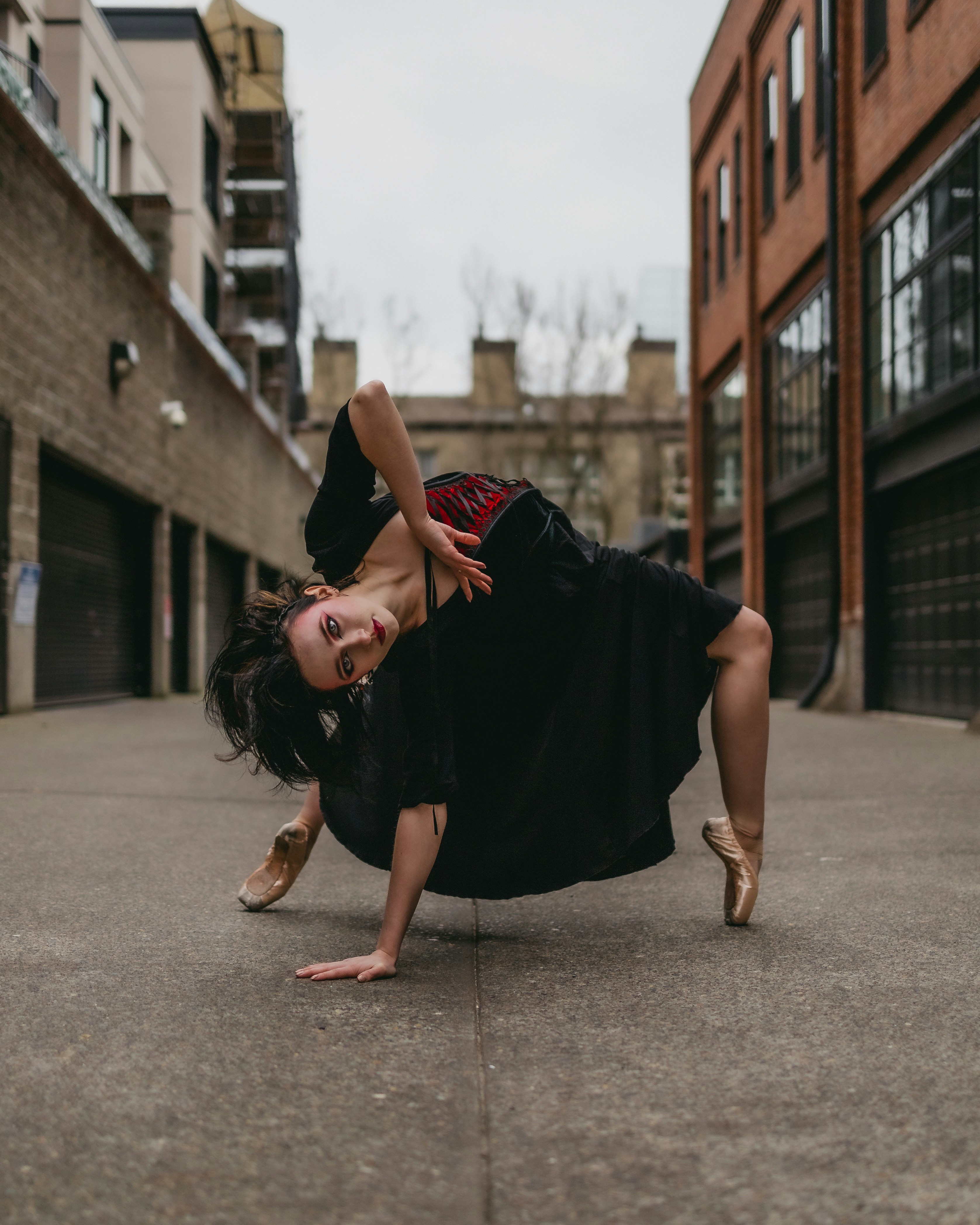 Dancer in black dress performs an urban ballet pose. photo – Free Art ...
