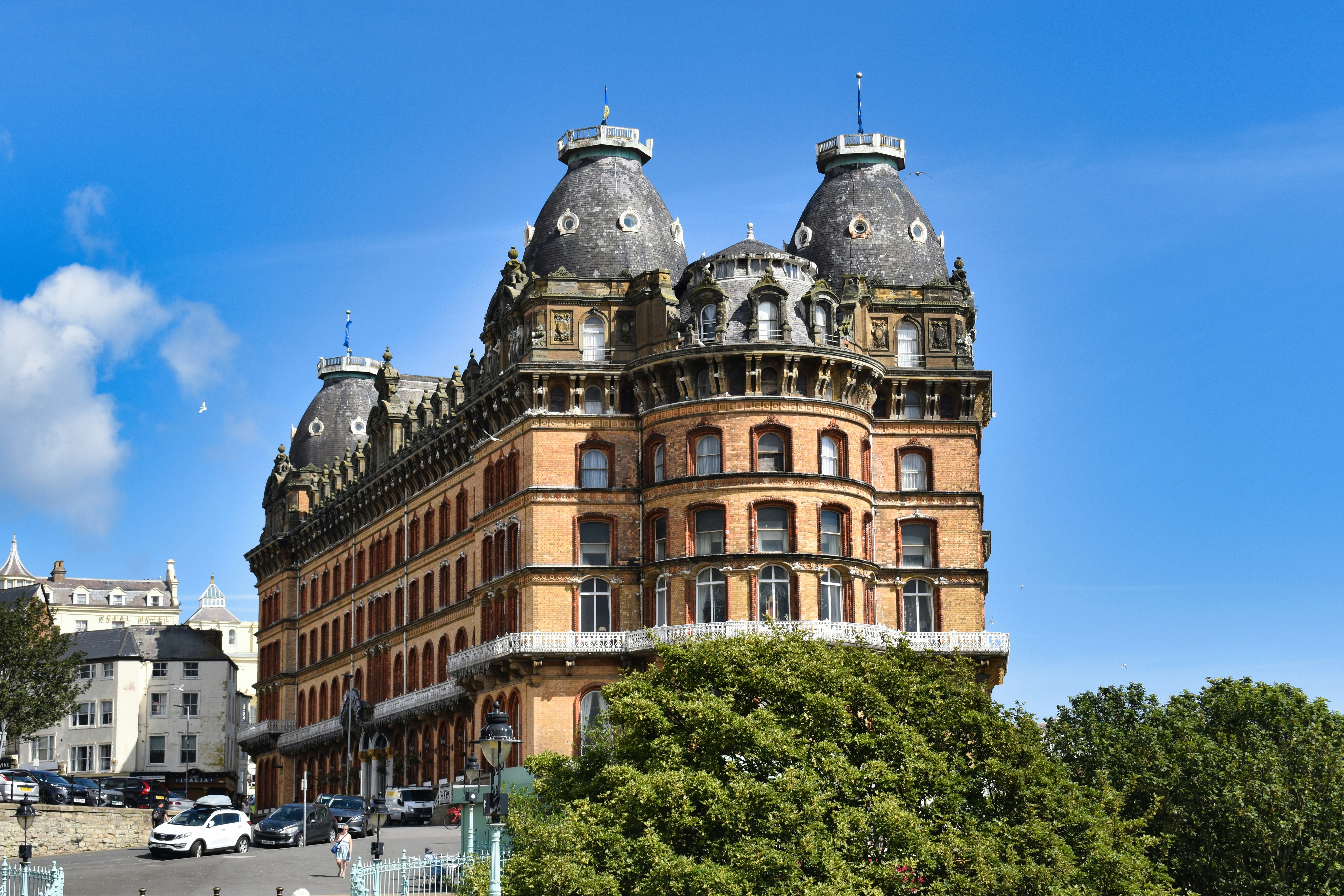 A grand building is viewed against a blue sky.