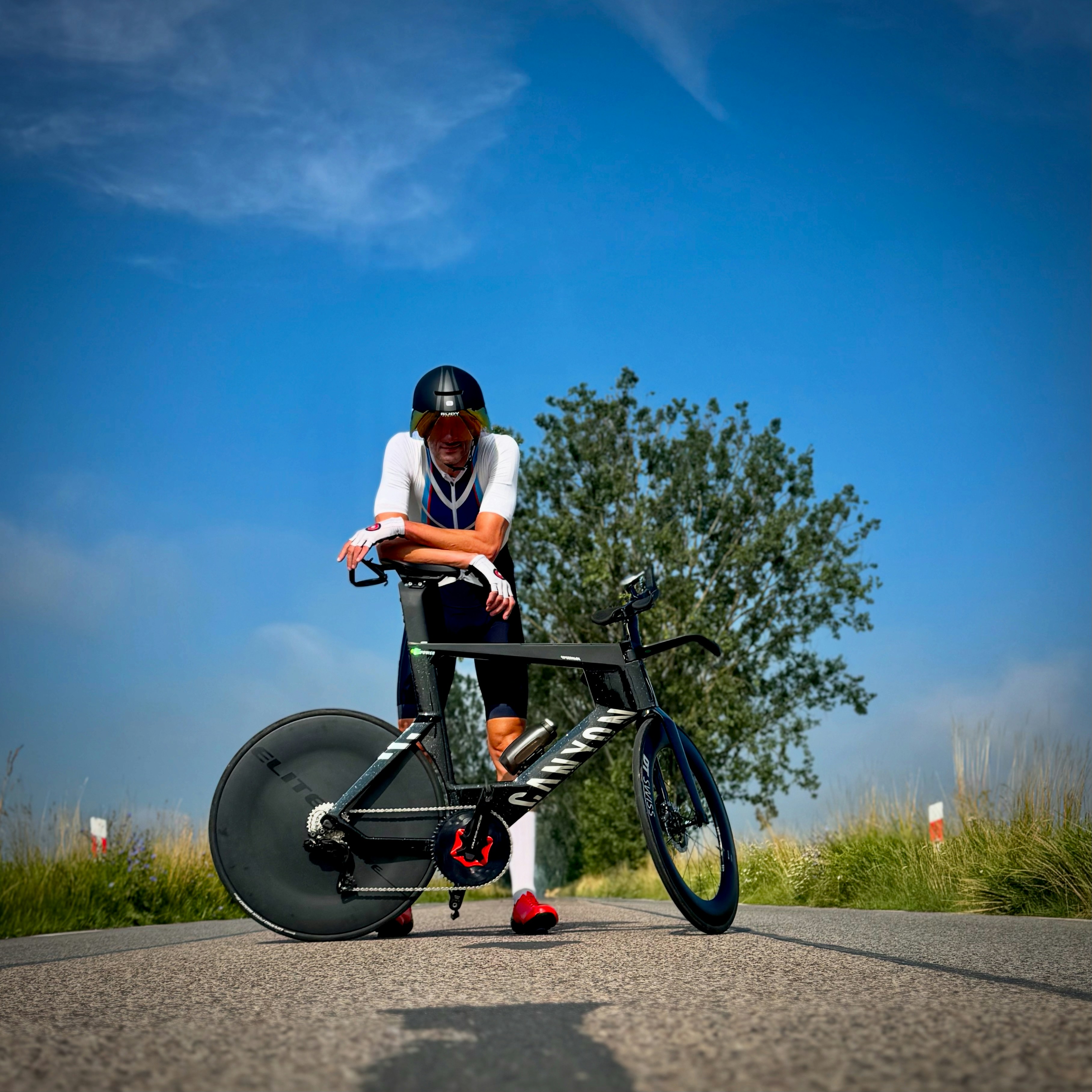 Cyclist with a Time Trial Road Bike on an Open rural road