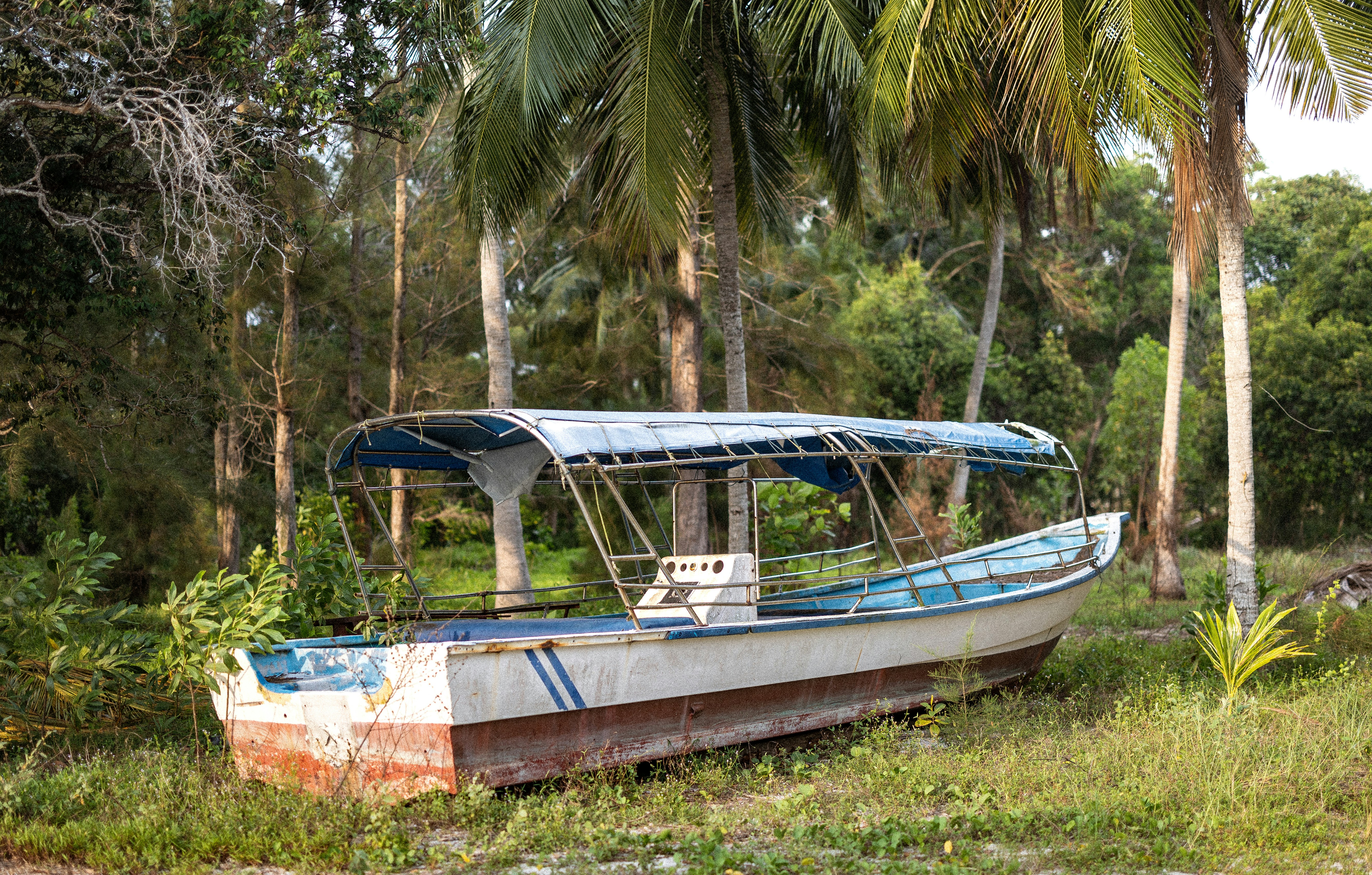 "Parking Spot" | An old boat rests on the shore.