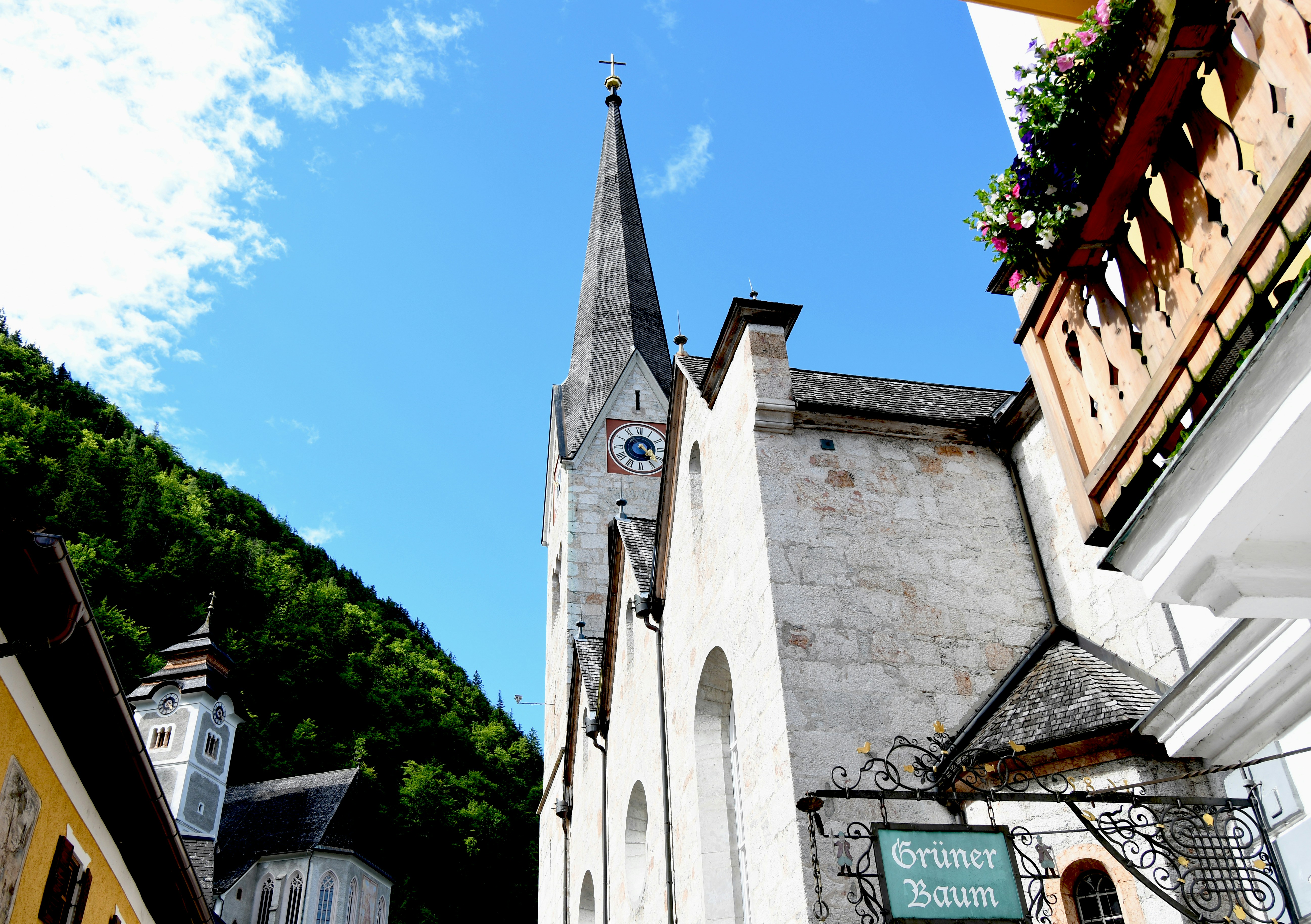 A tall church steeple against a bright blue sky.