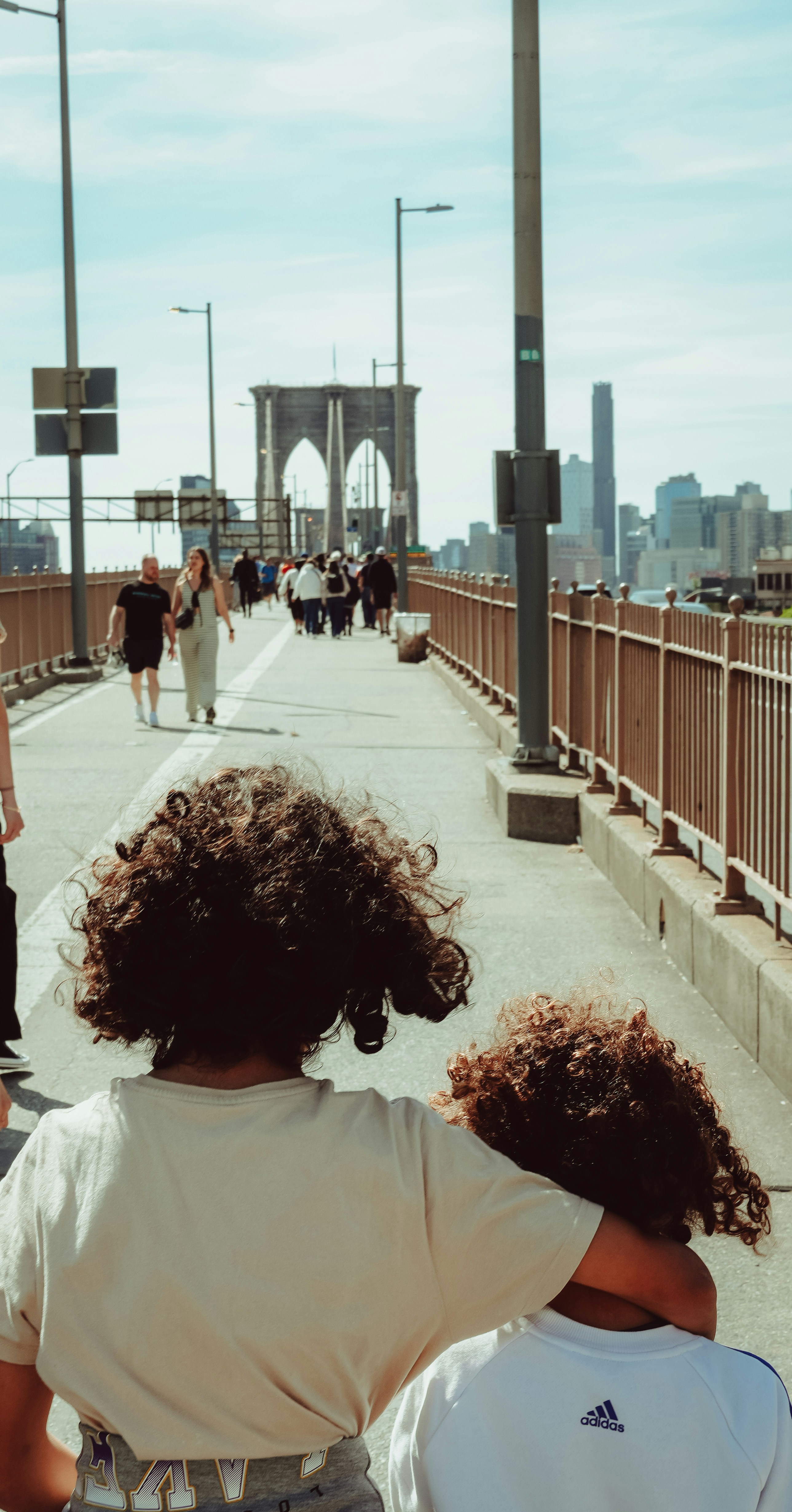 Siblings on the Brooklyn Bridge: A Moment of Togetherness