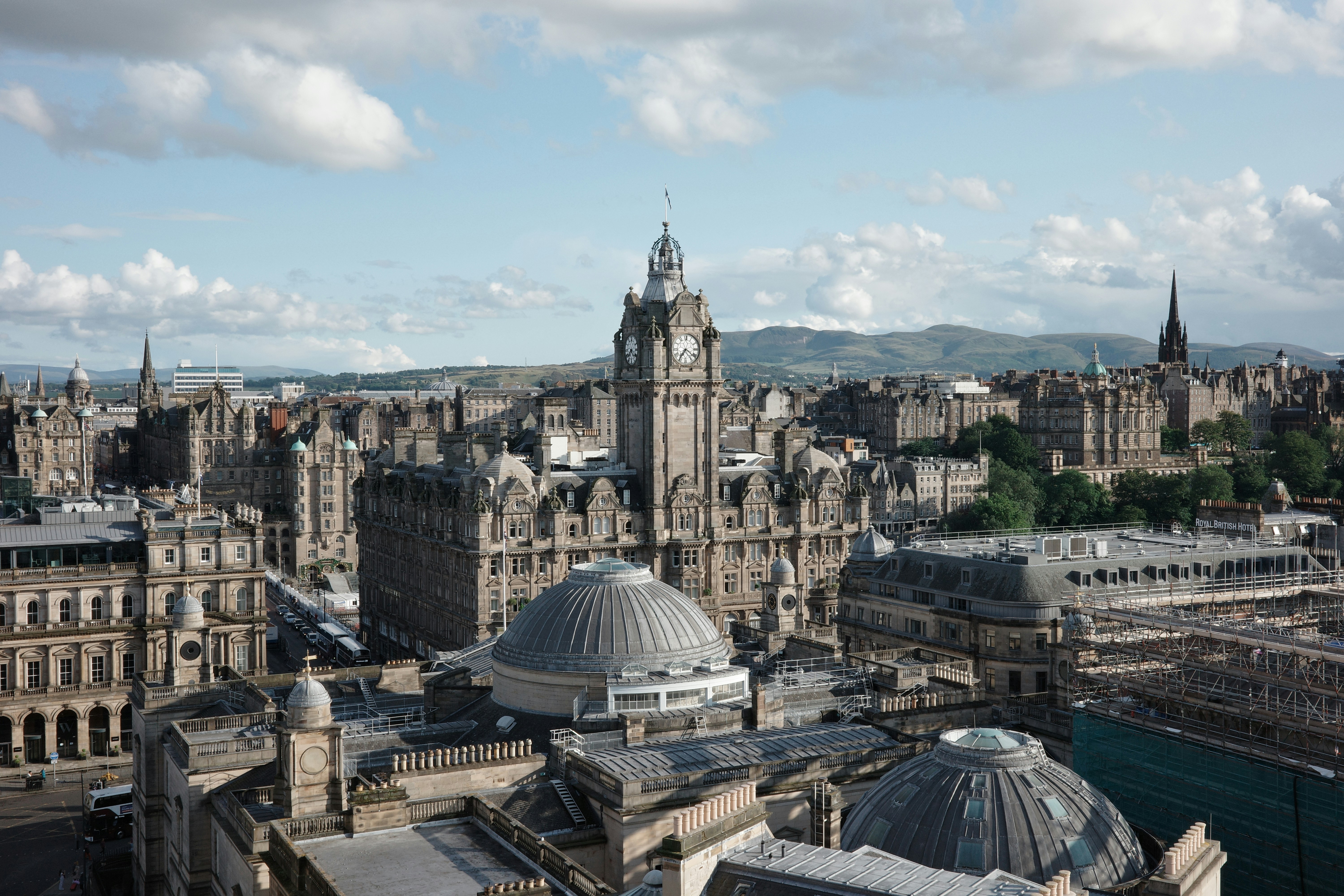 Edinburgh's beautiful skyline stretches beneath a cloudy sky.